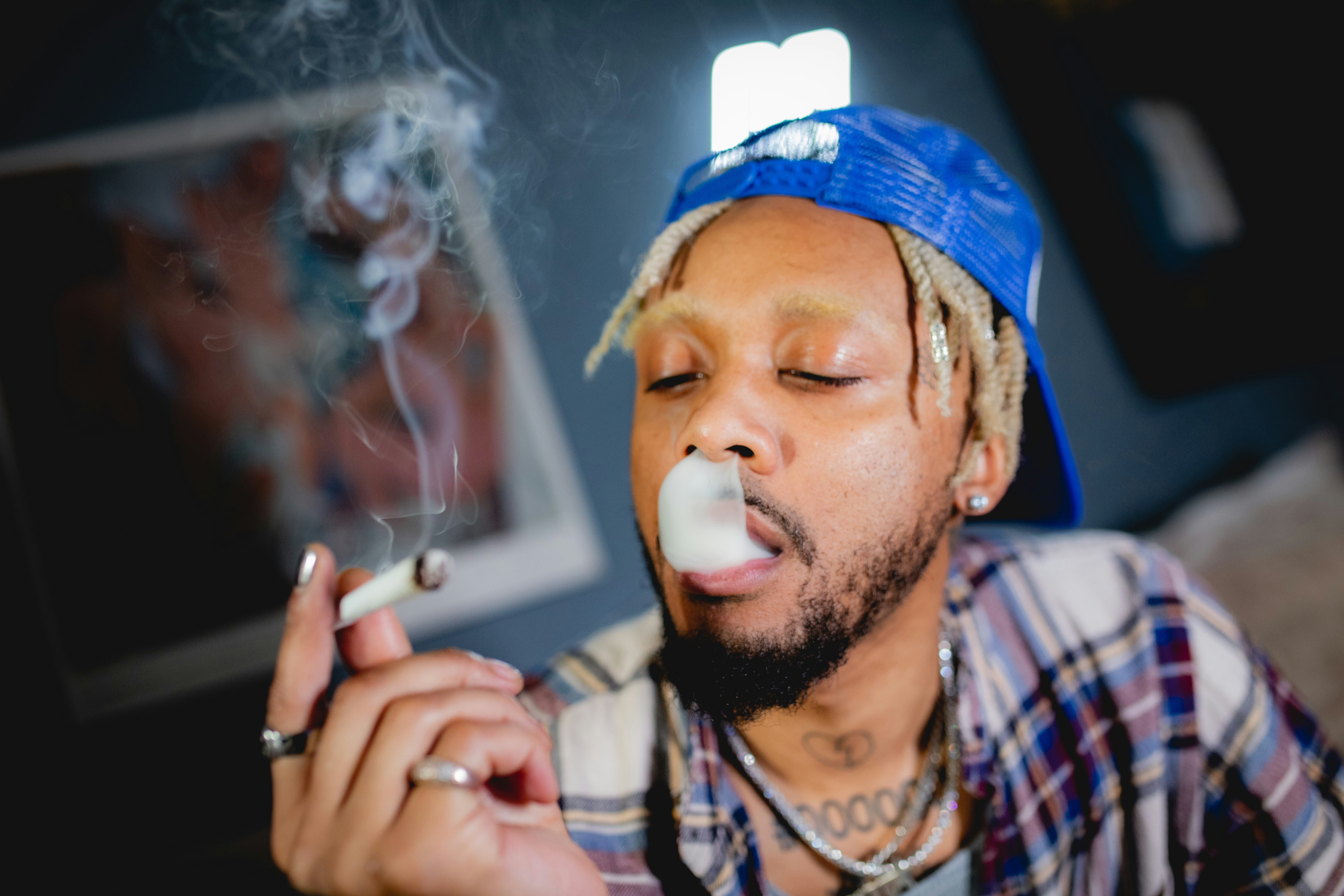 Blue Cap, Soft Light: A Portrait of Quiet Intensity with Smoke
