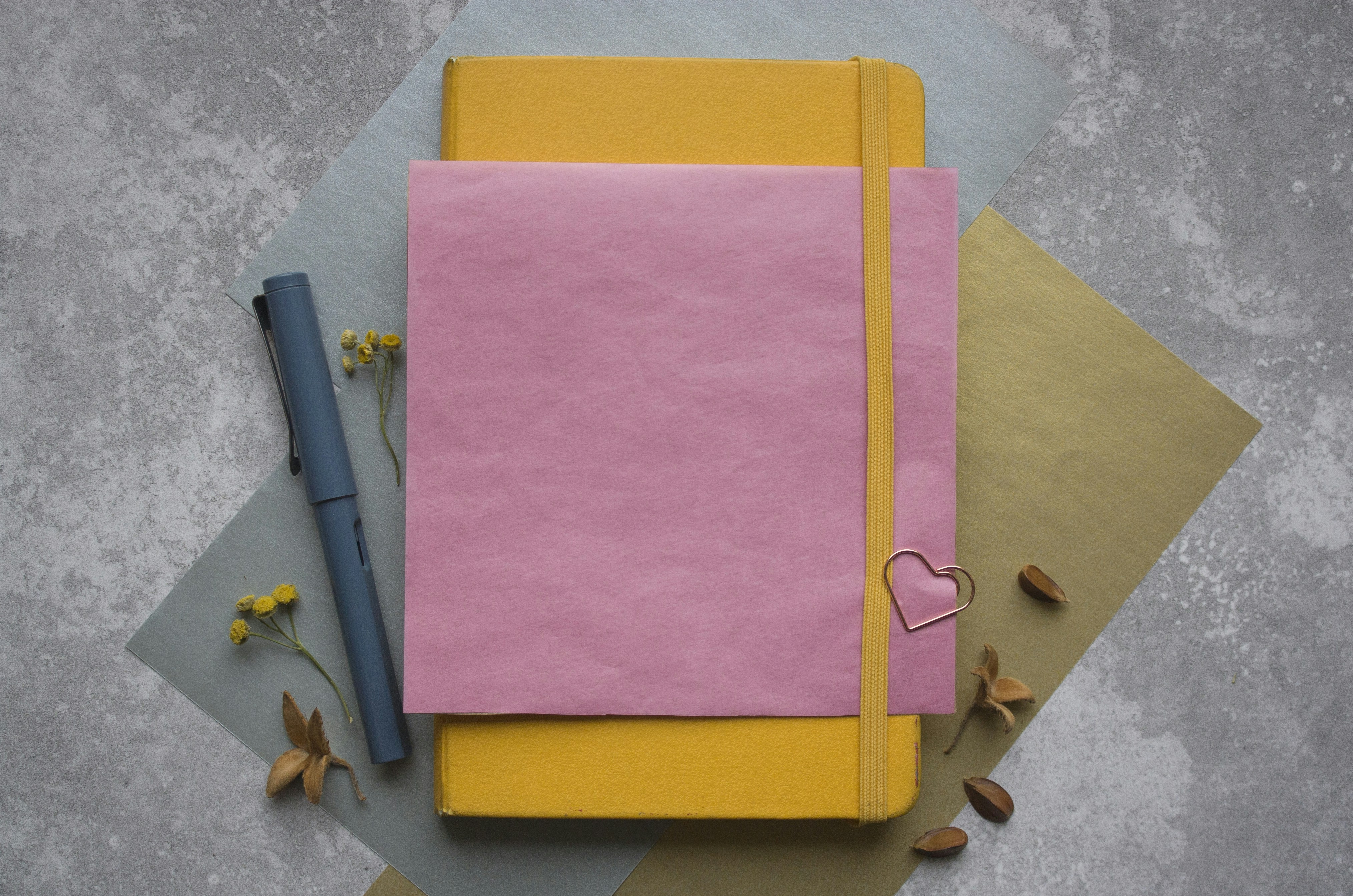 A pink and yellow notebook with a heart on it photo – Free Silver paper ...