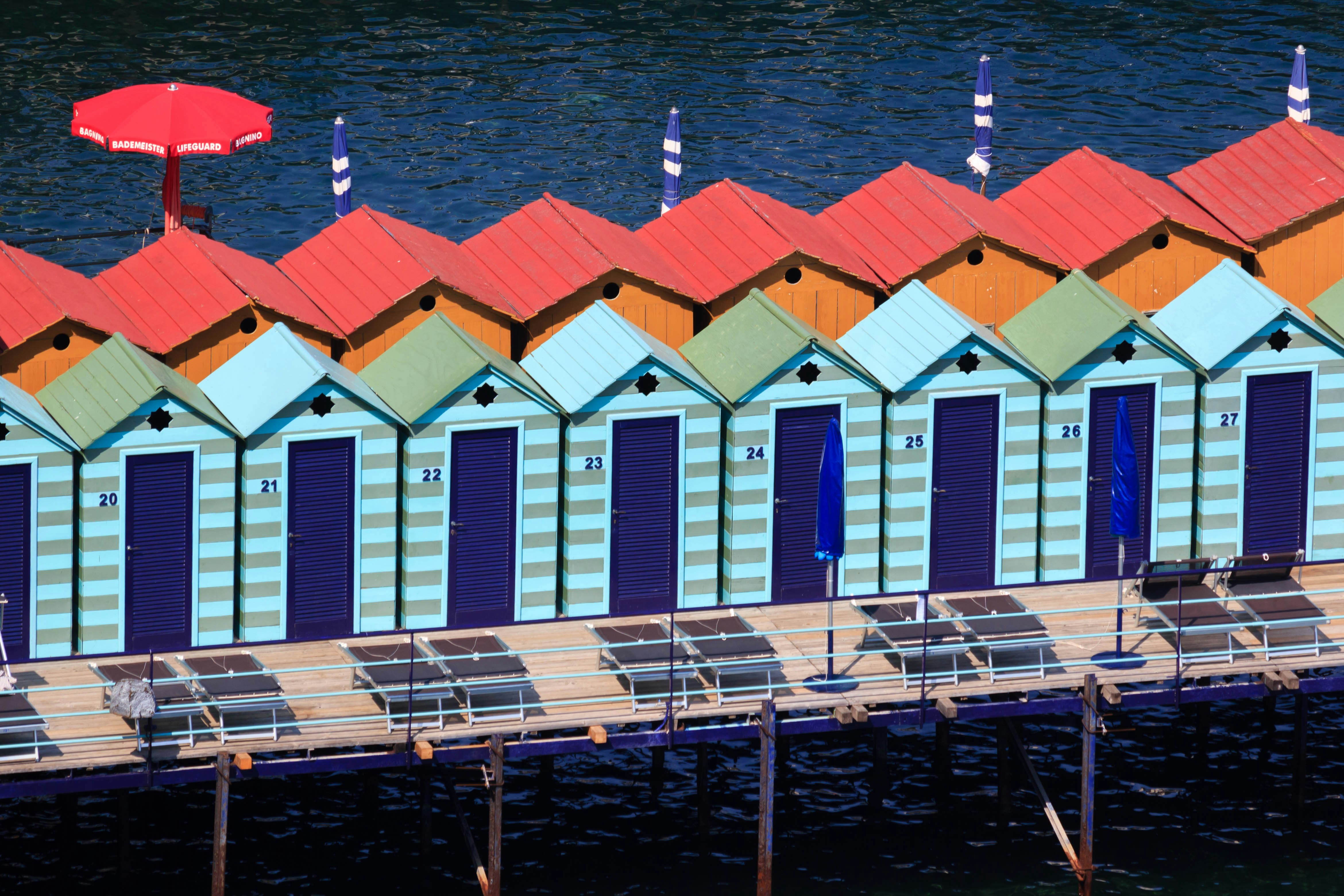 A row of beach huts sitting on top of a pier photo – Free Sorrento ...