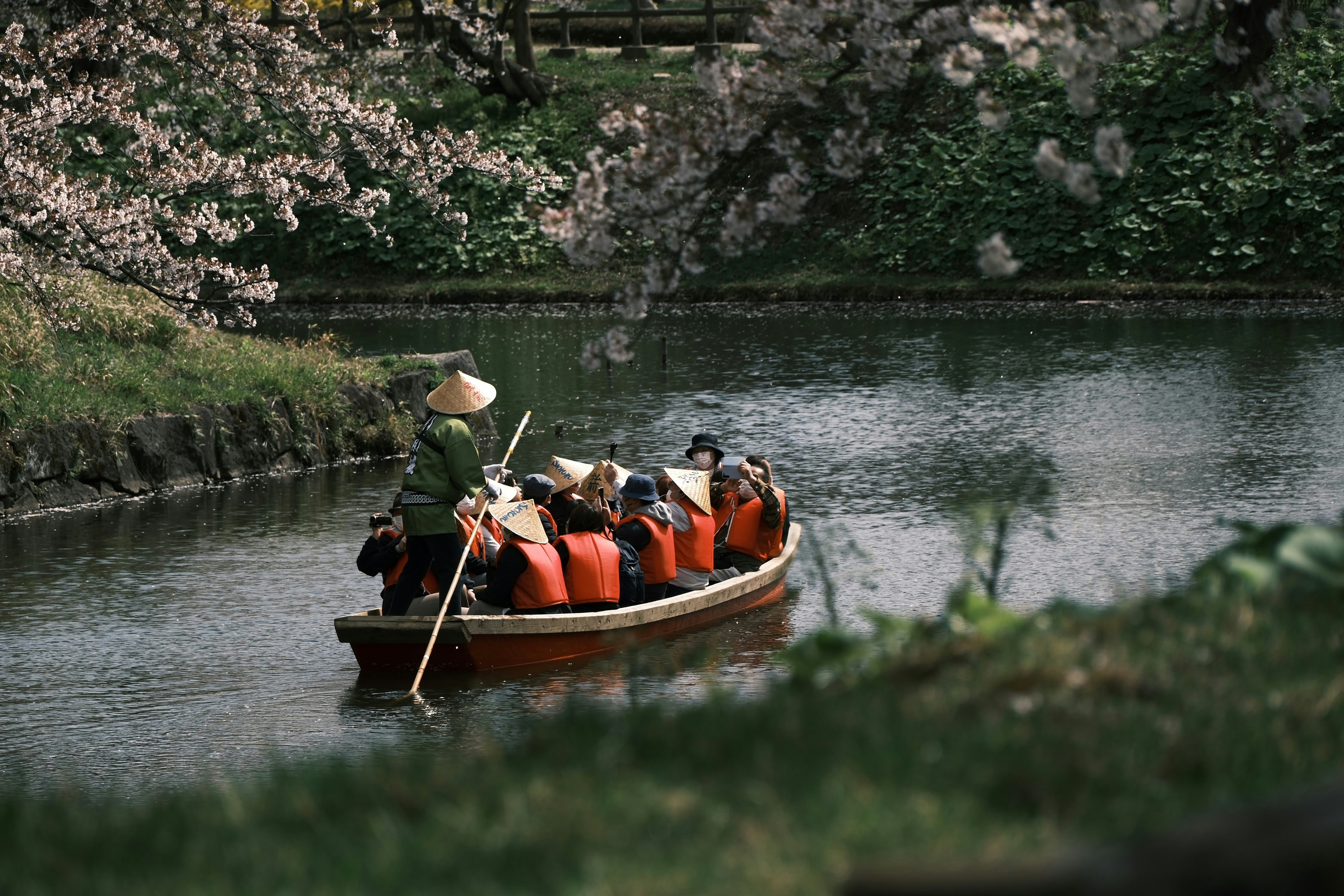 a group of people in a boat on a river