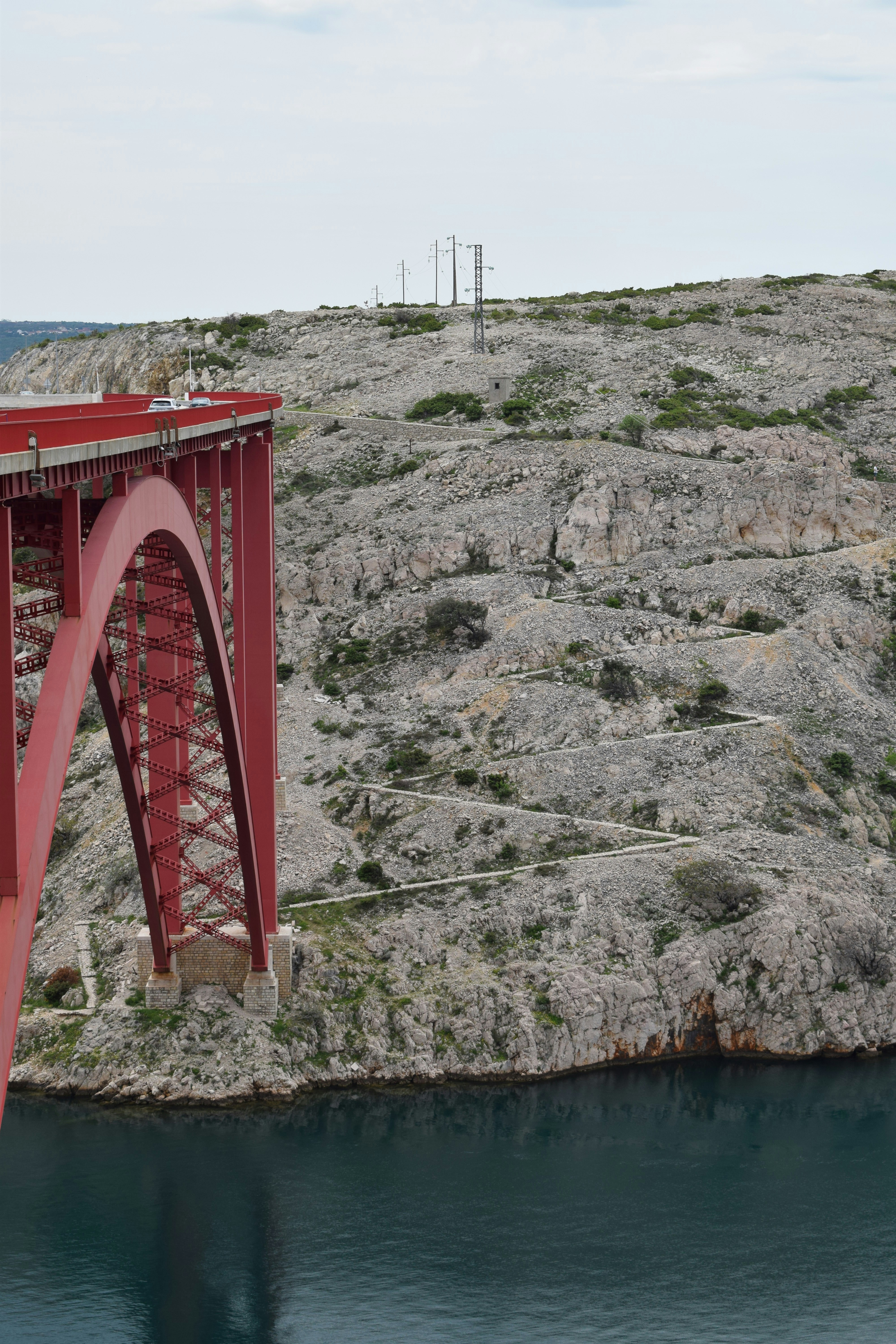 Crimson Arch Over a Rugged Coastal Gorge