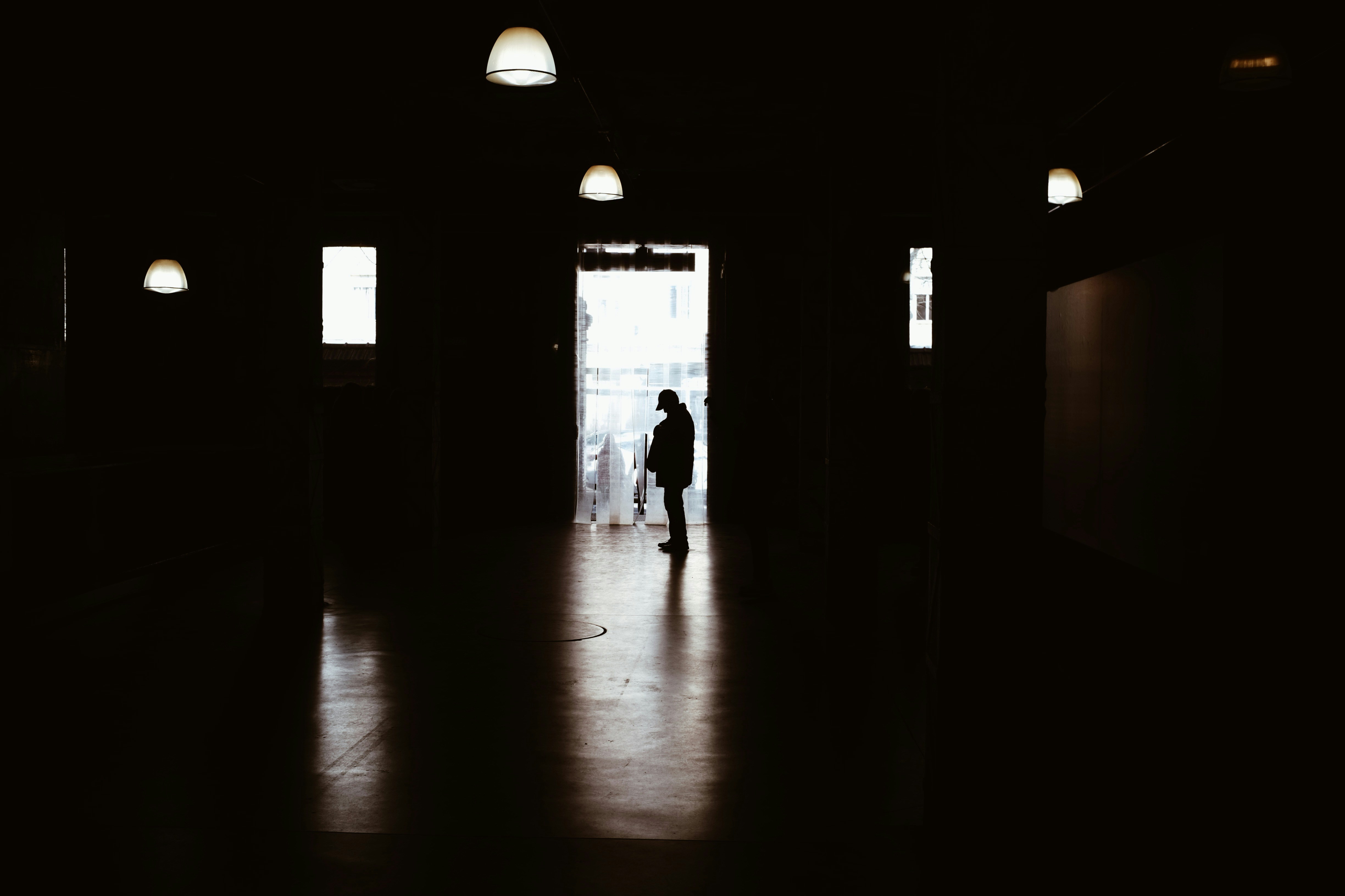 A couple of people standing in a dark room photo – Free Madrid Image on ...