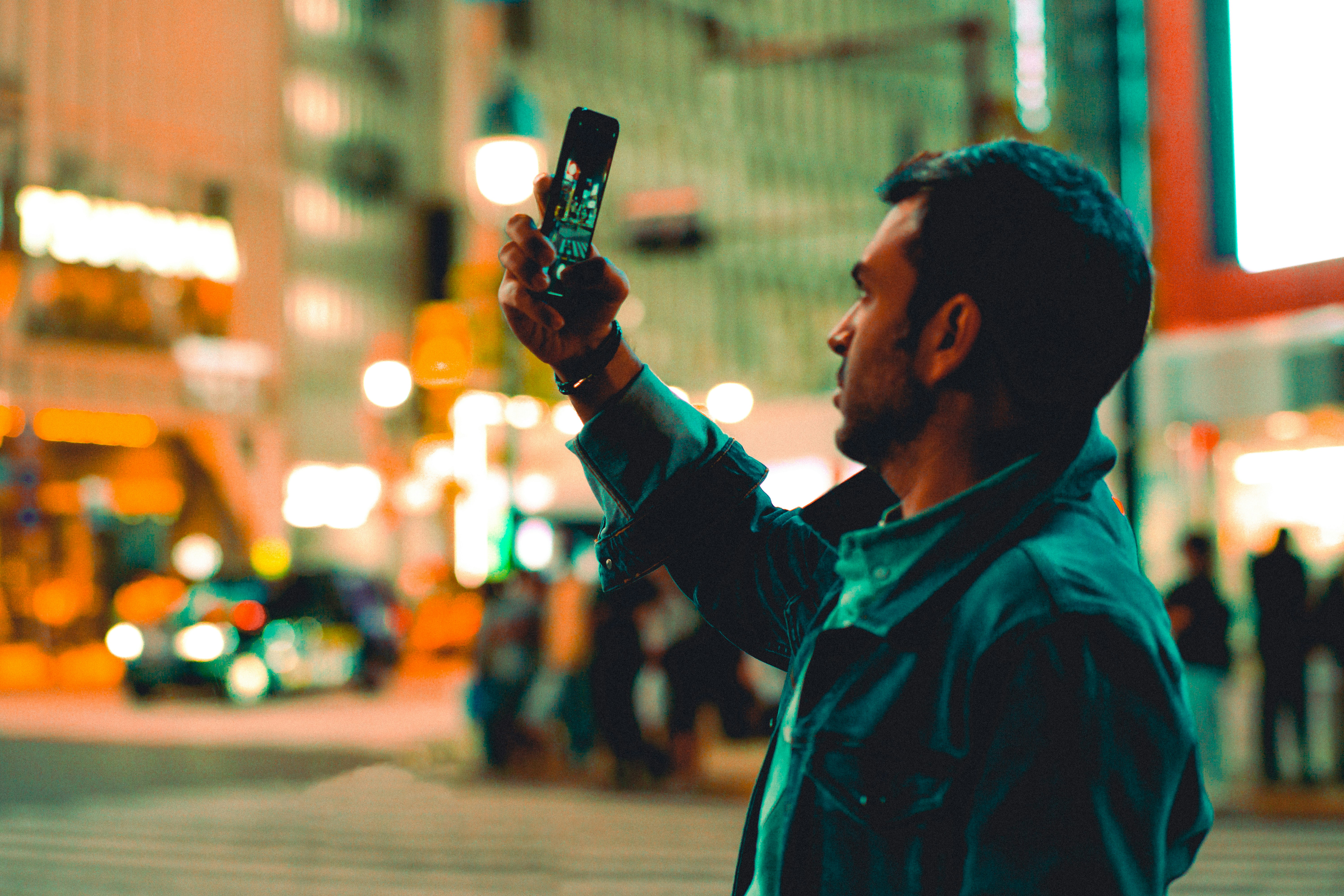 A man taking a picture with his cell phone photo – Free Man Image on ...