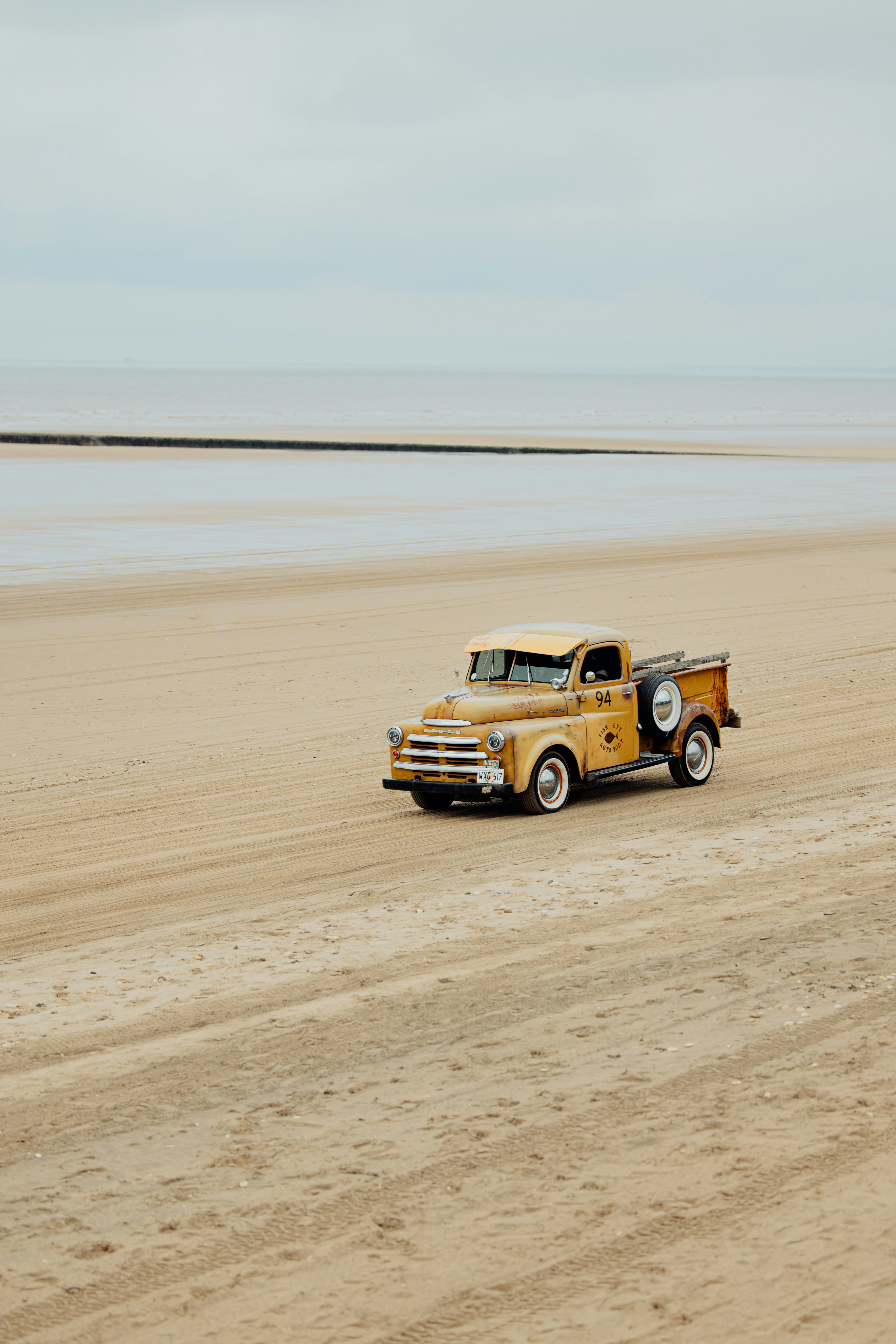 Retro Yellow Pickup Rides the Quiet Shoreline