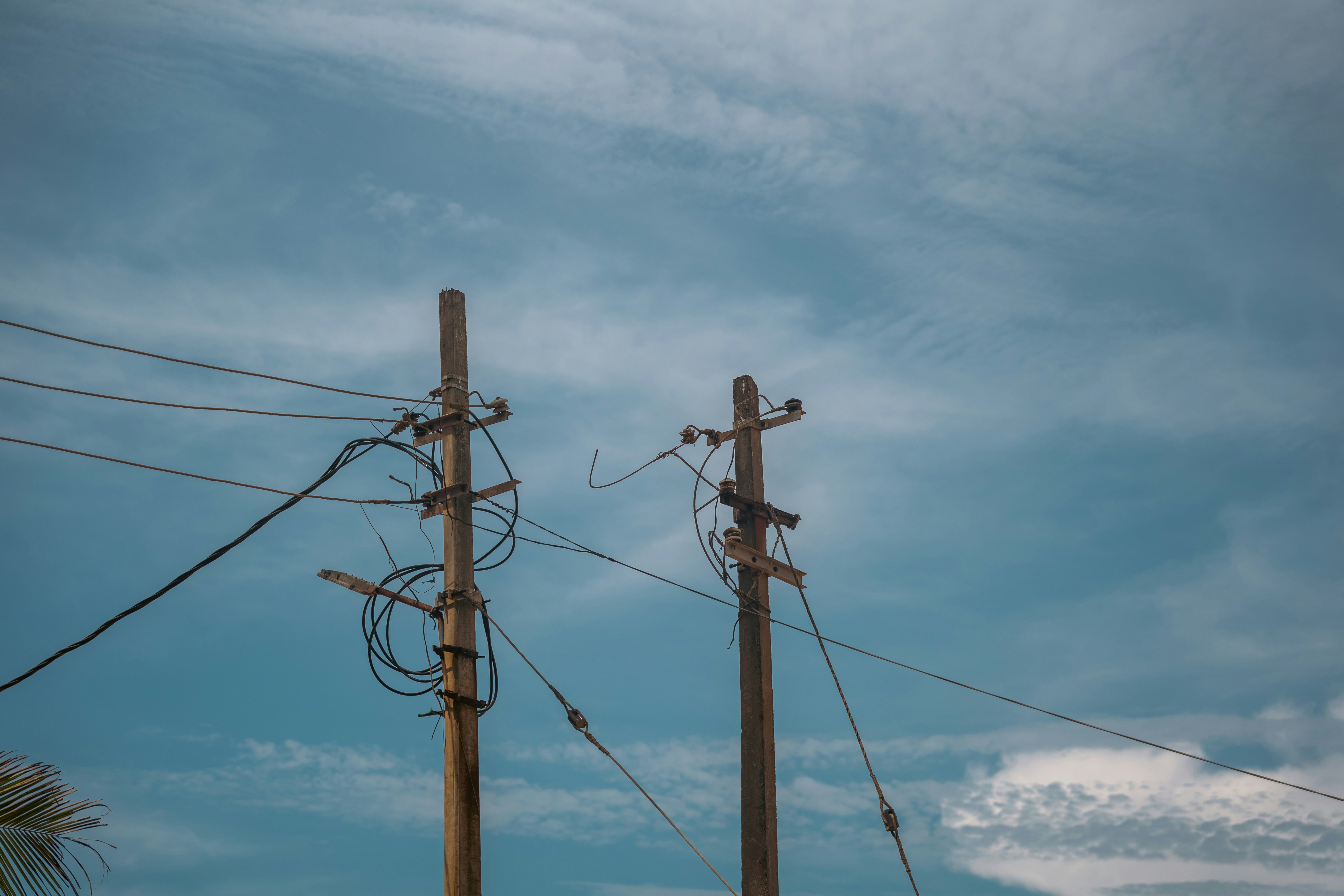 Two telephone poles with wires and wires attached to them photo – Free ...