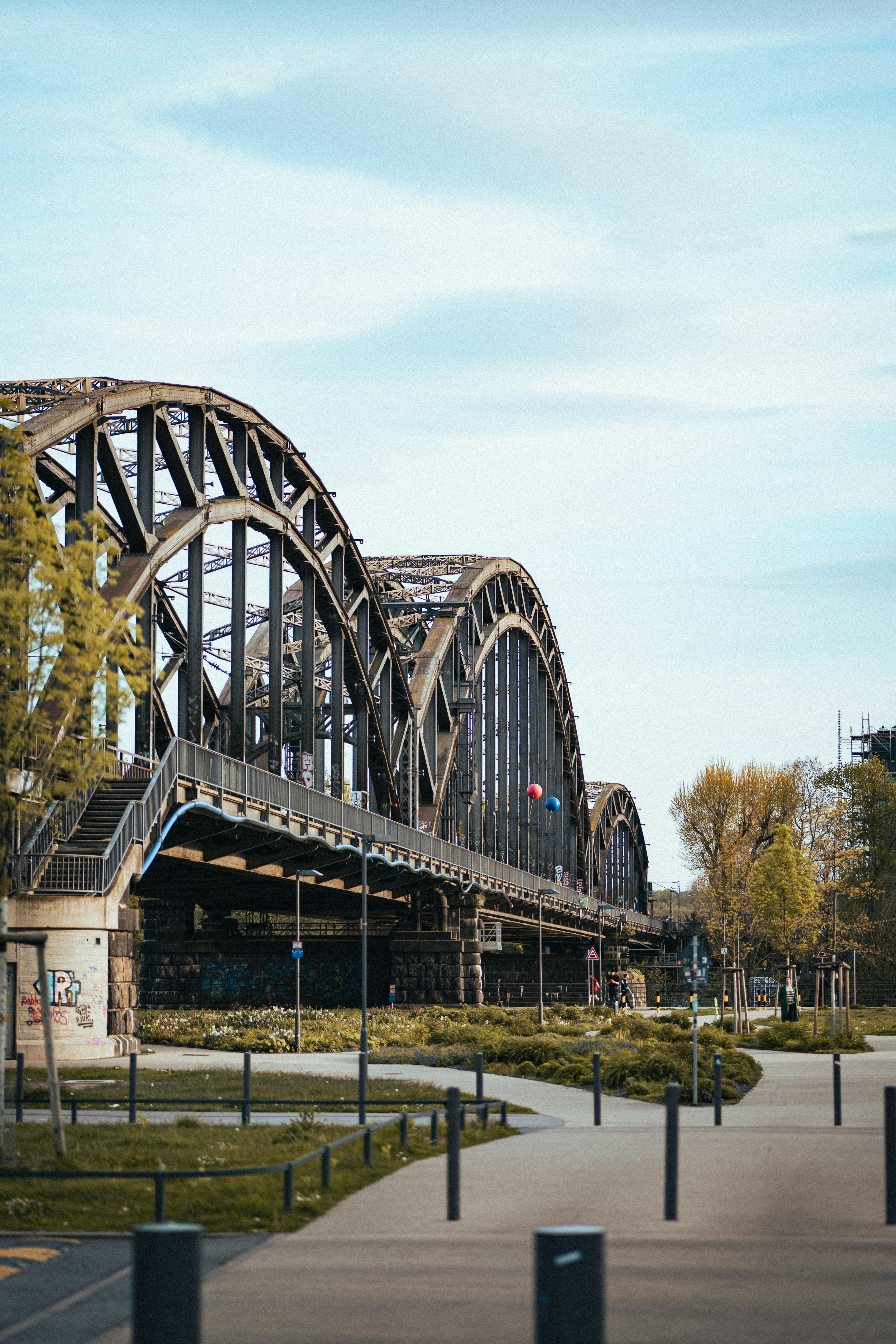 Archways Over the River: A Riverside Stroll Beneath Steel Arches