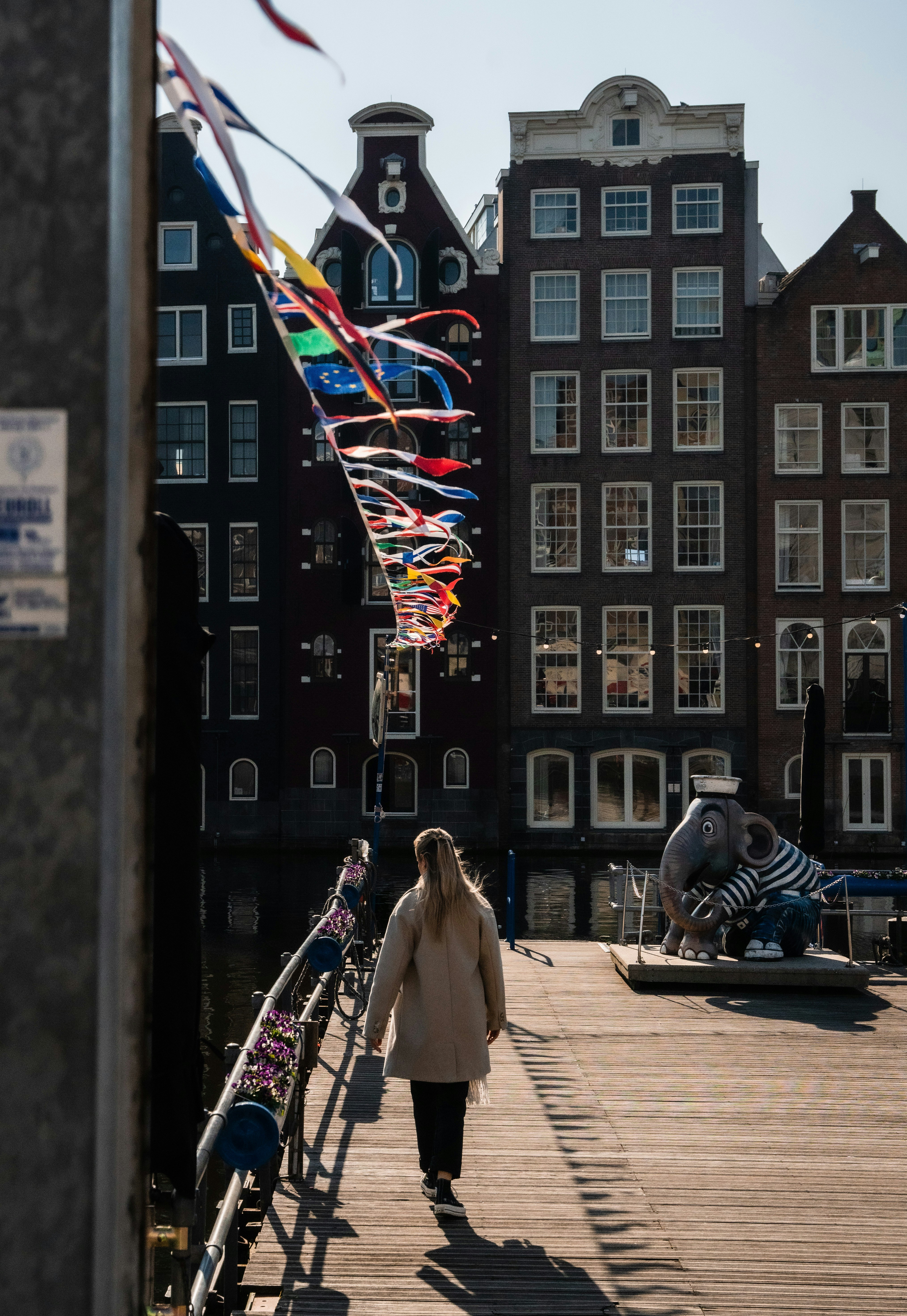 Flag-Striped Canal Walk: A Quiet Amsterdam Moment