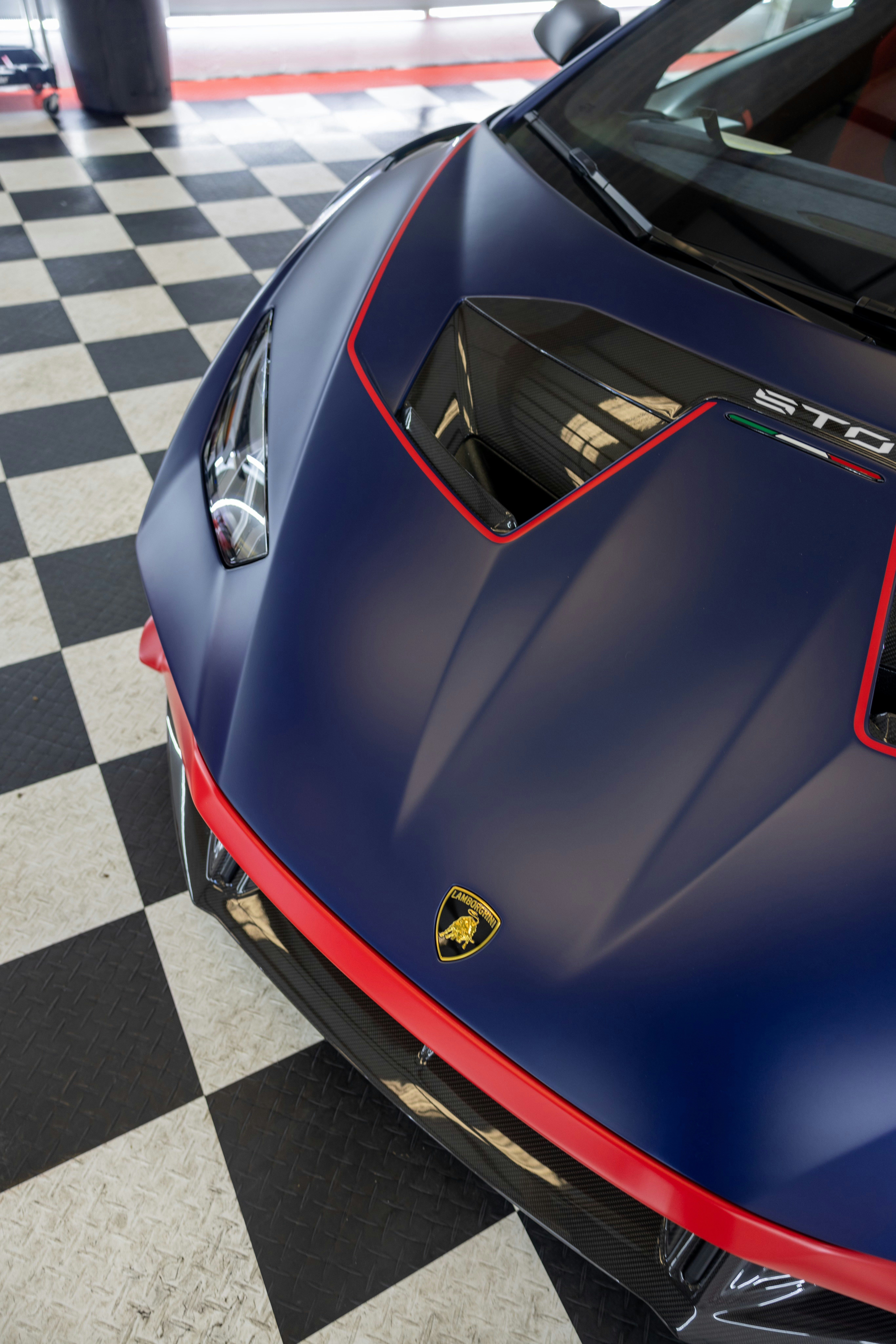 A blue and red sports car on a checkered floor photo – Free Vehicle ...