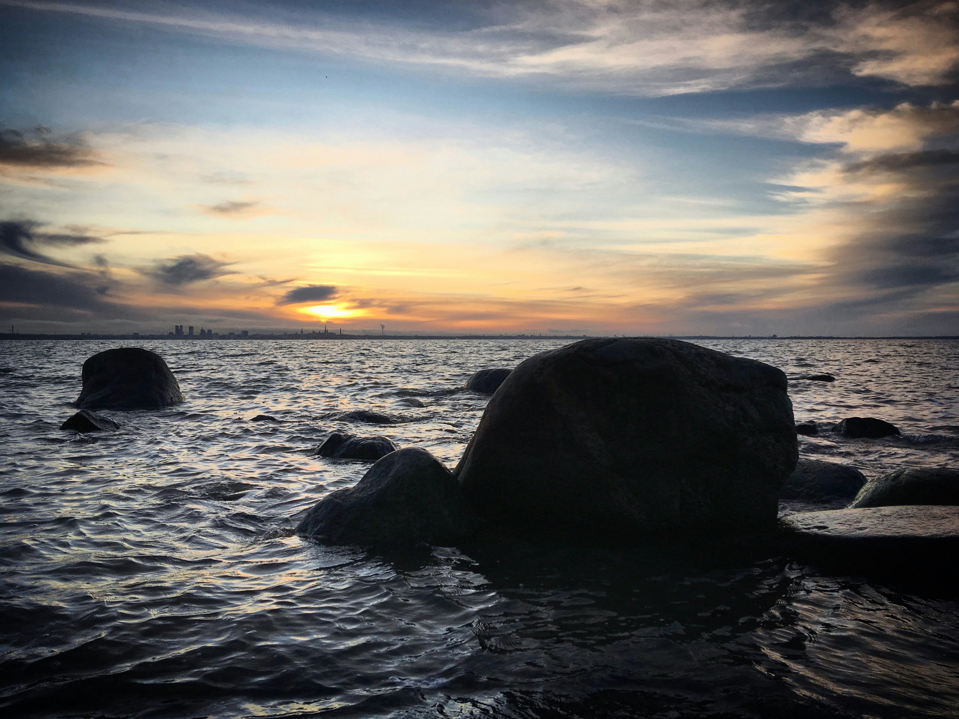 Sunset over the stones on the Pirita beach, Tallinn, Estonia, November 2017