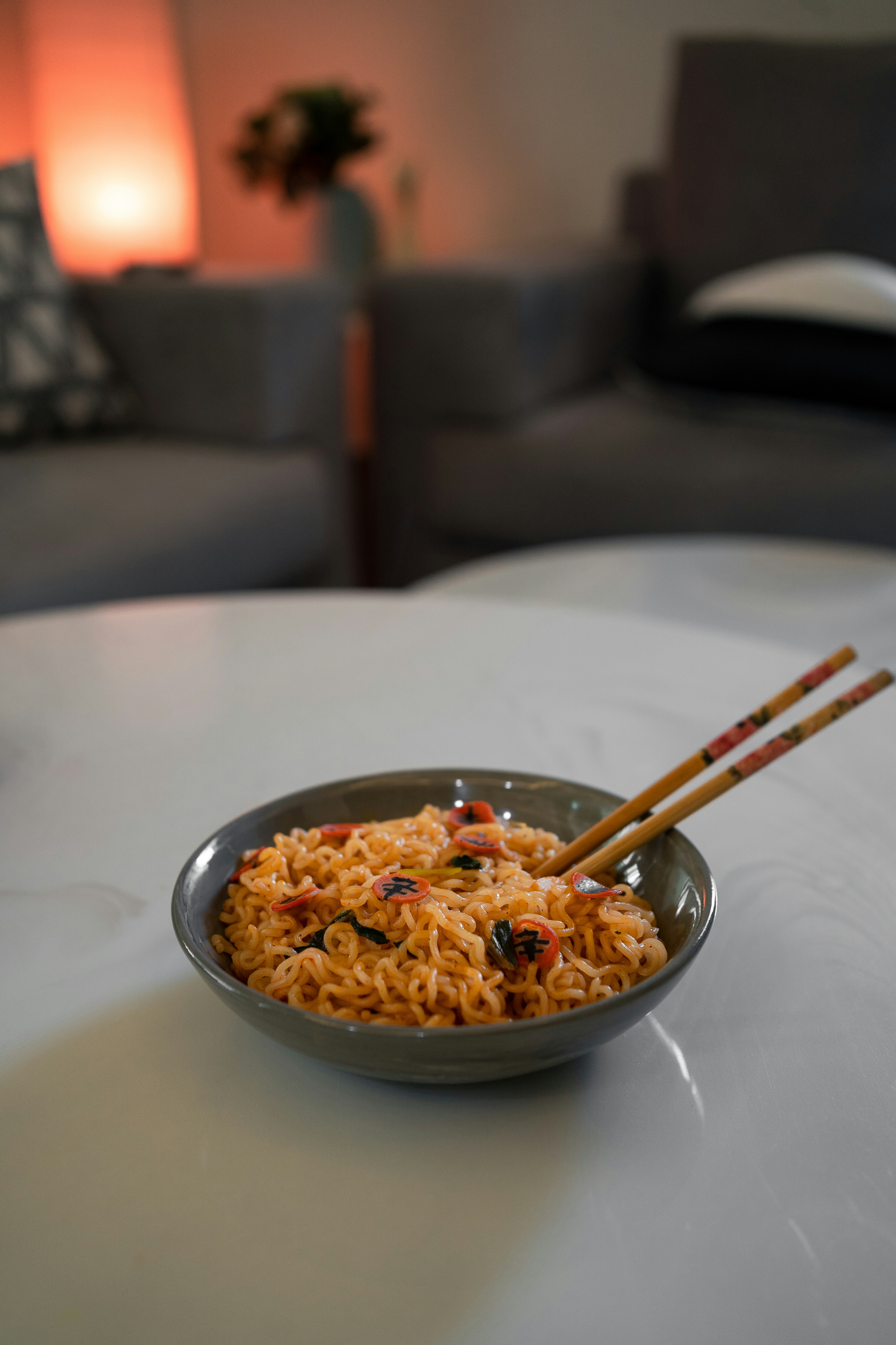 Cozy Glow and Ramen: A Bowl of Noodles in a Quiet Living Room