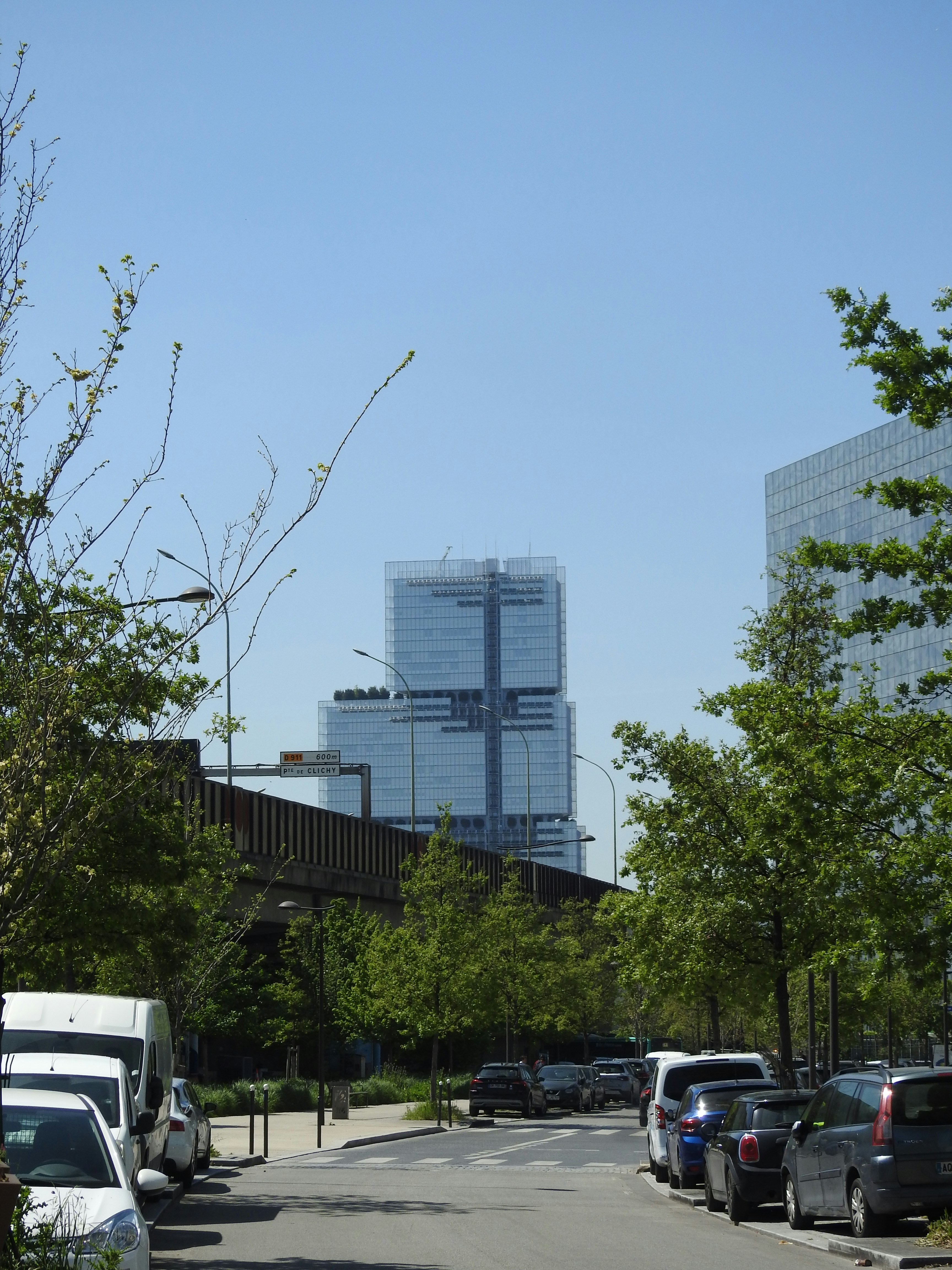 Glass Monoliths Amid a Tree-Lined Downtown Street