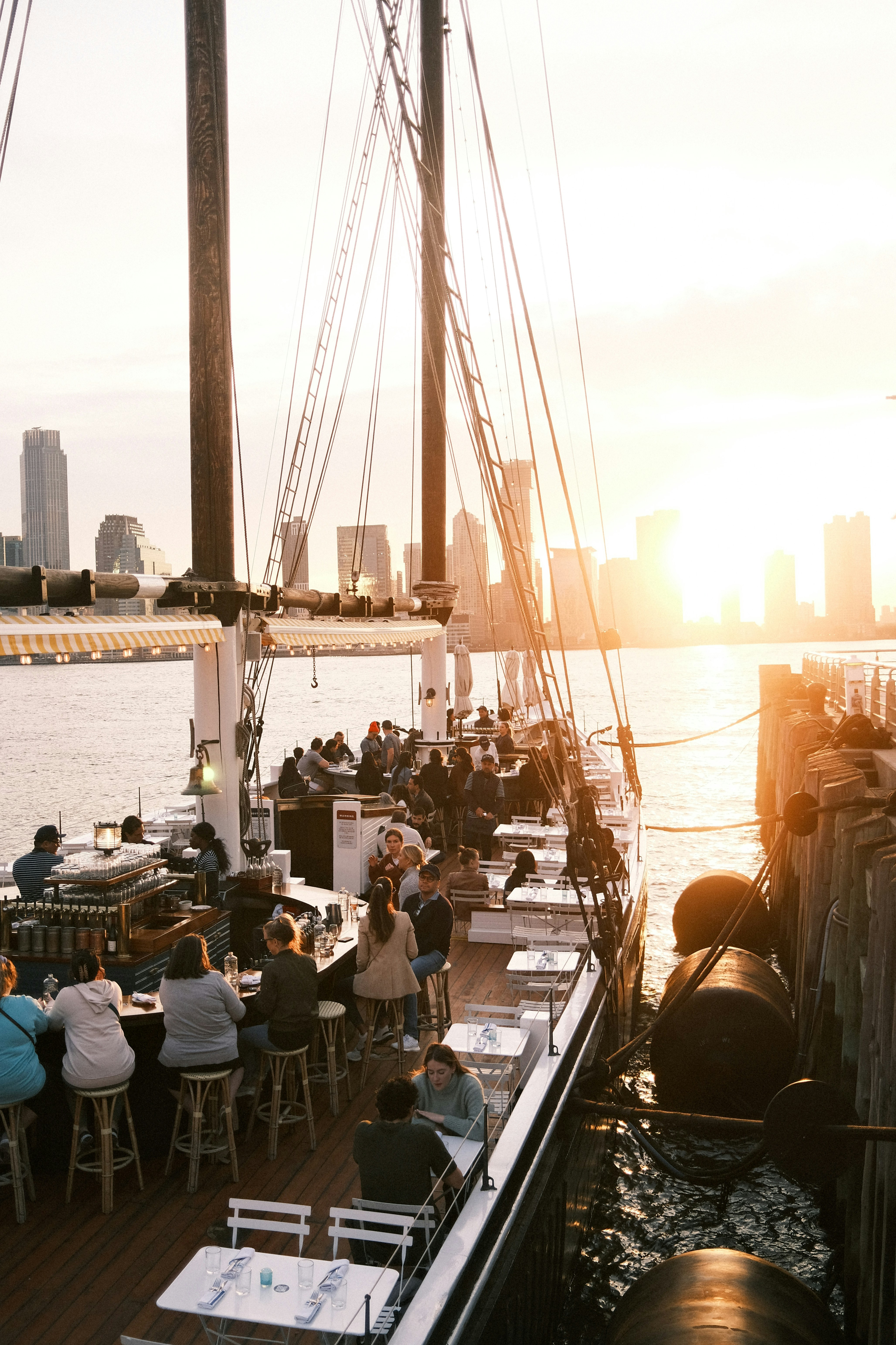 Evening Feast Aboard: City Skyline Ignites the Deck