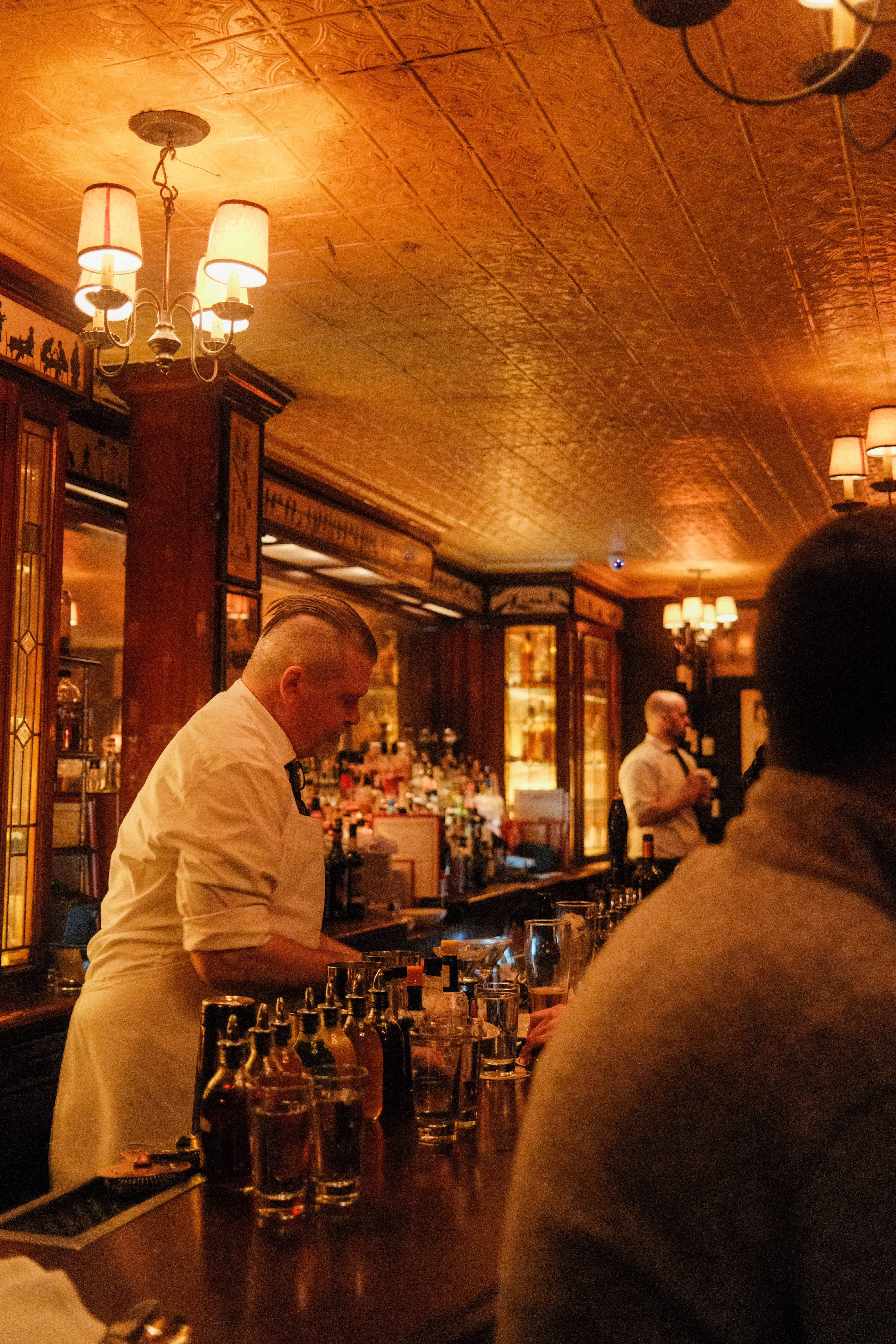 A man standing at a bar preparing drinks photo – Free New york Image on ...