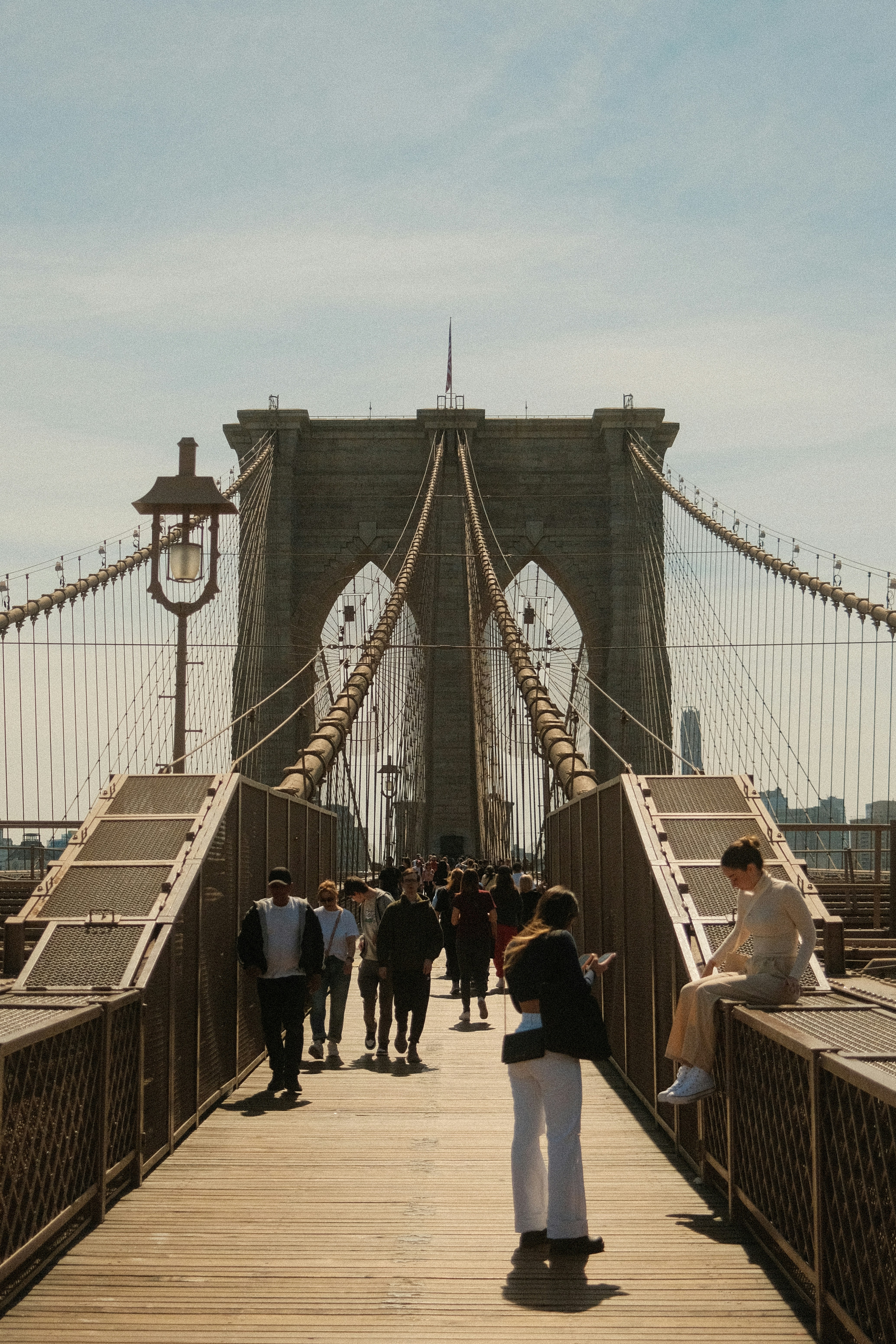 A group of people walking across a bridge photo – Free Brooklyn bridge ...