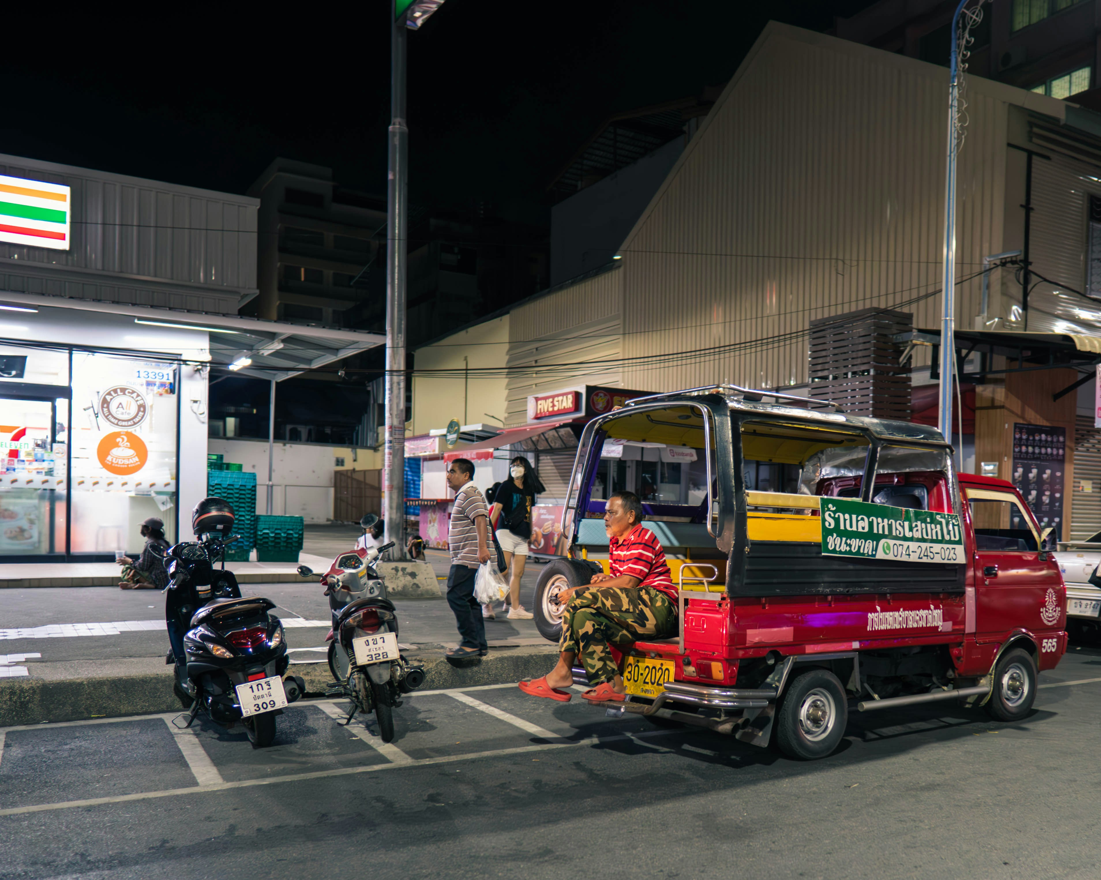 Midnight Neon: A Red Tuk-Tuk Anchors a Bangkok Street Scene