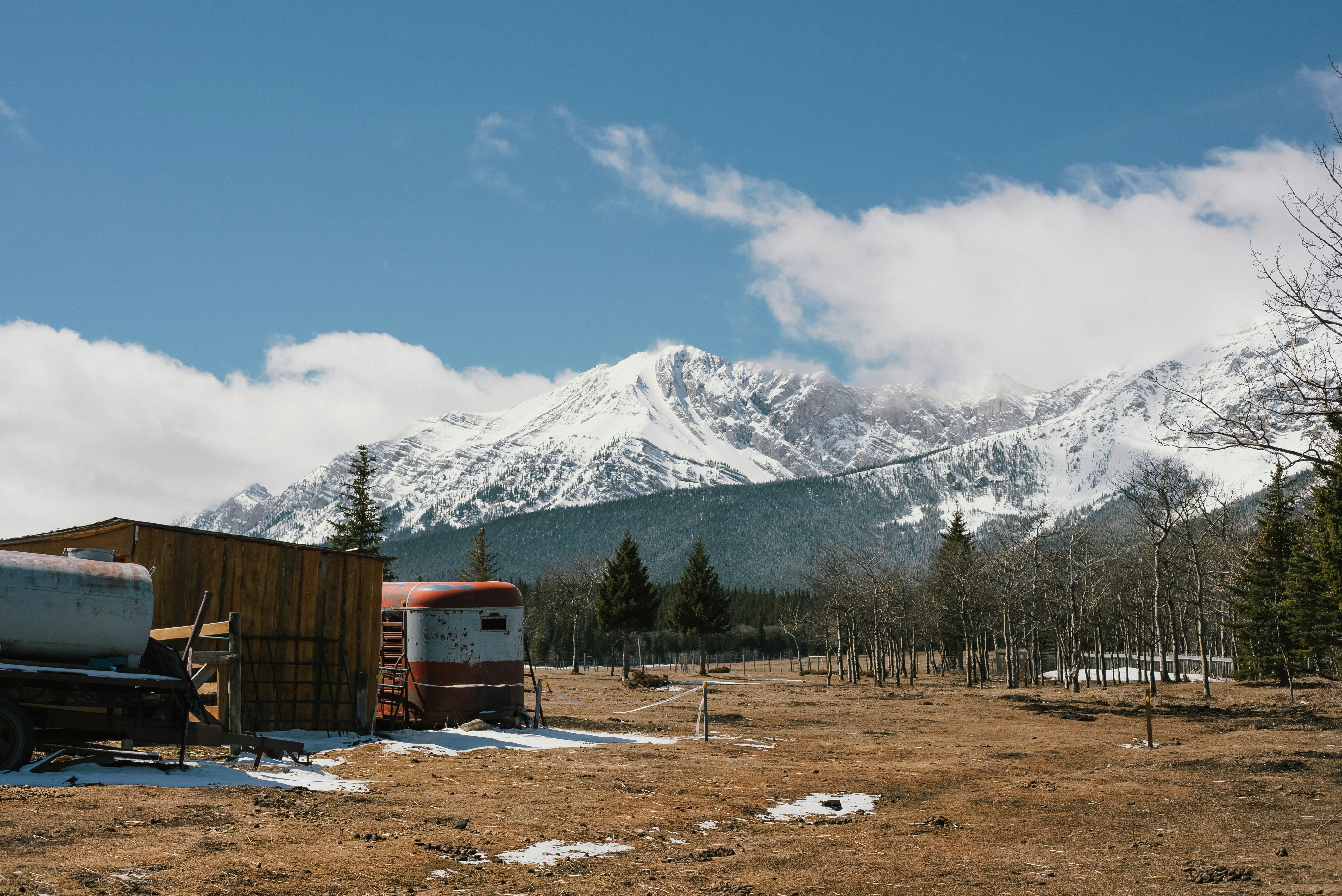 Snow-Trimmed Peaks Over a Rustic Trailer Yard
