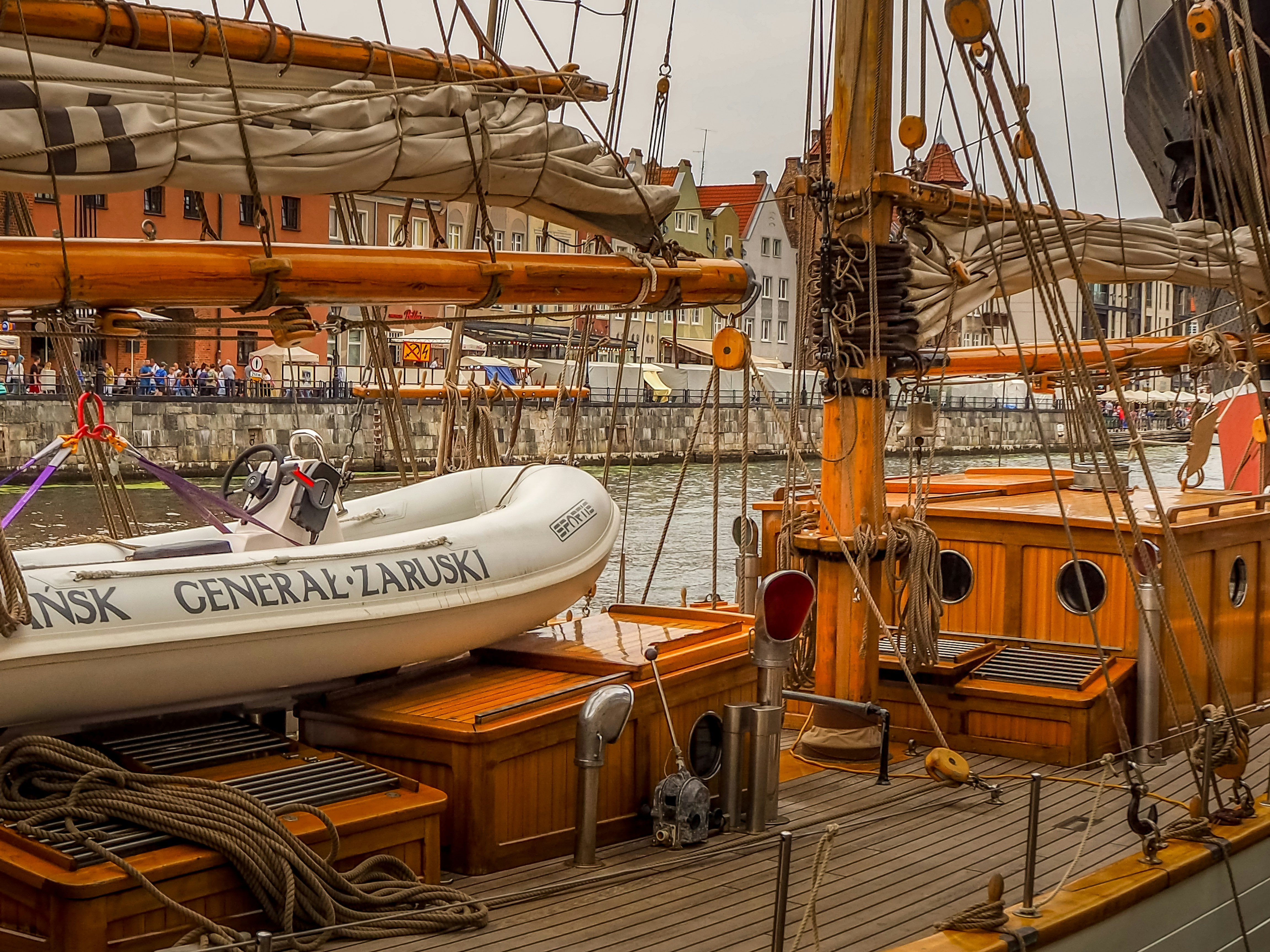Tangled Rigging, Quiet Harbor: A Wooden Deck with a White Dinghy