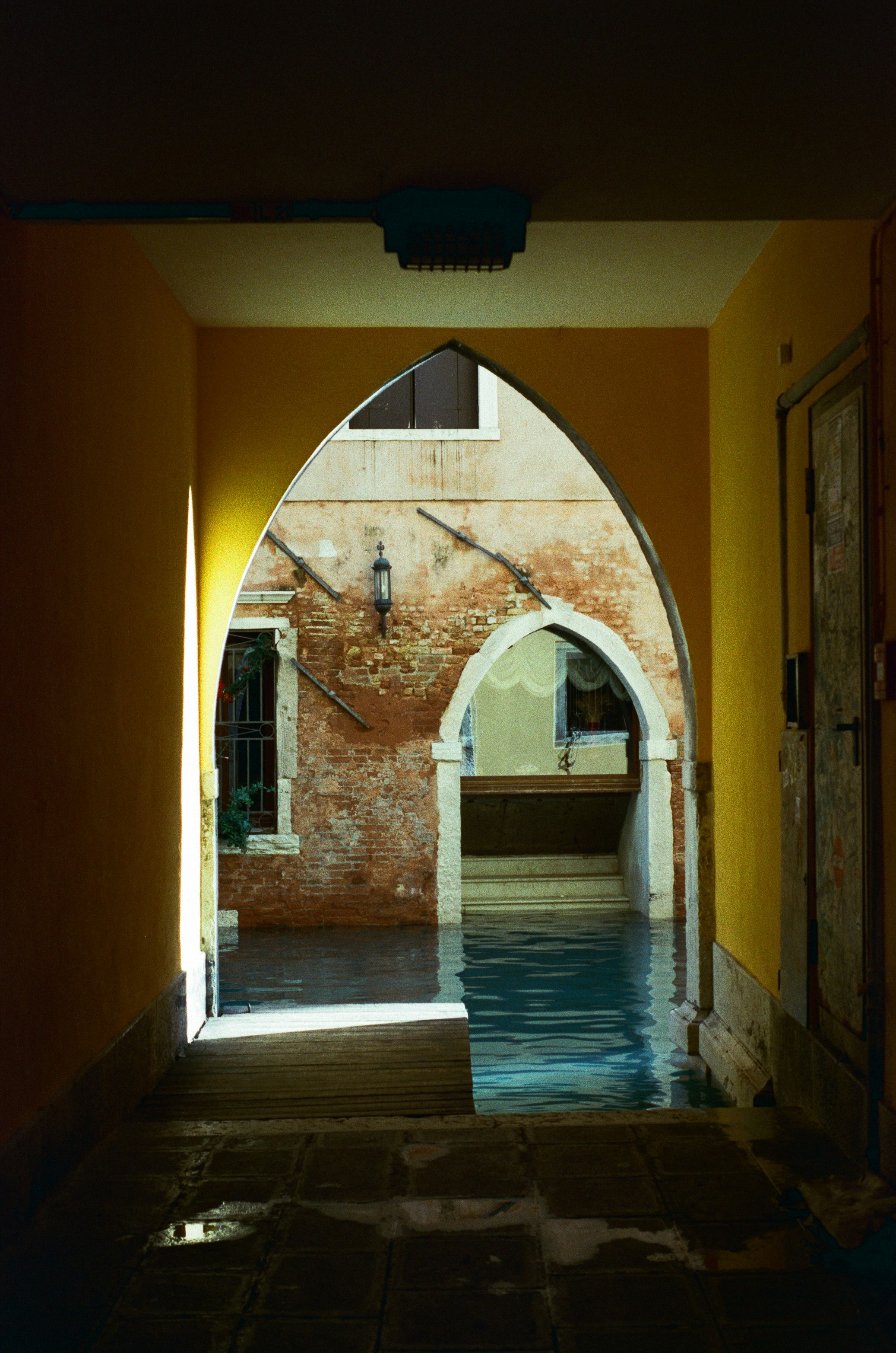 An archway leading to a swimming pool in a building photo – Free Venice ...