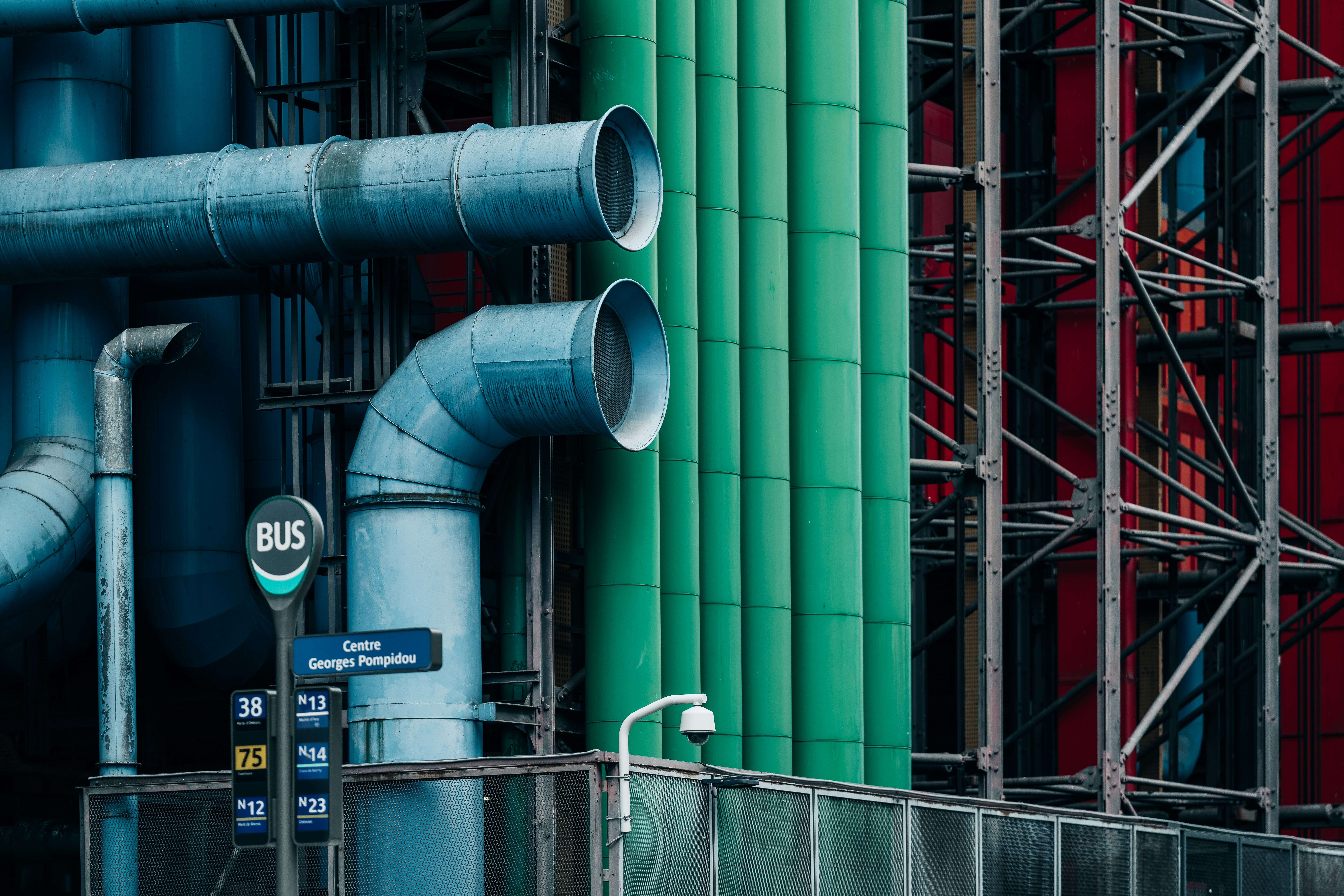 A building with pipes and a street sign photo – Free Paris Image on ...