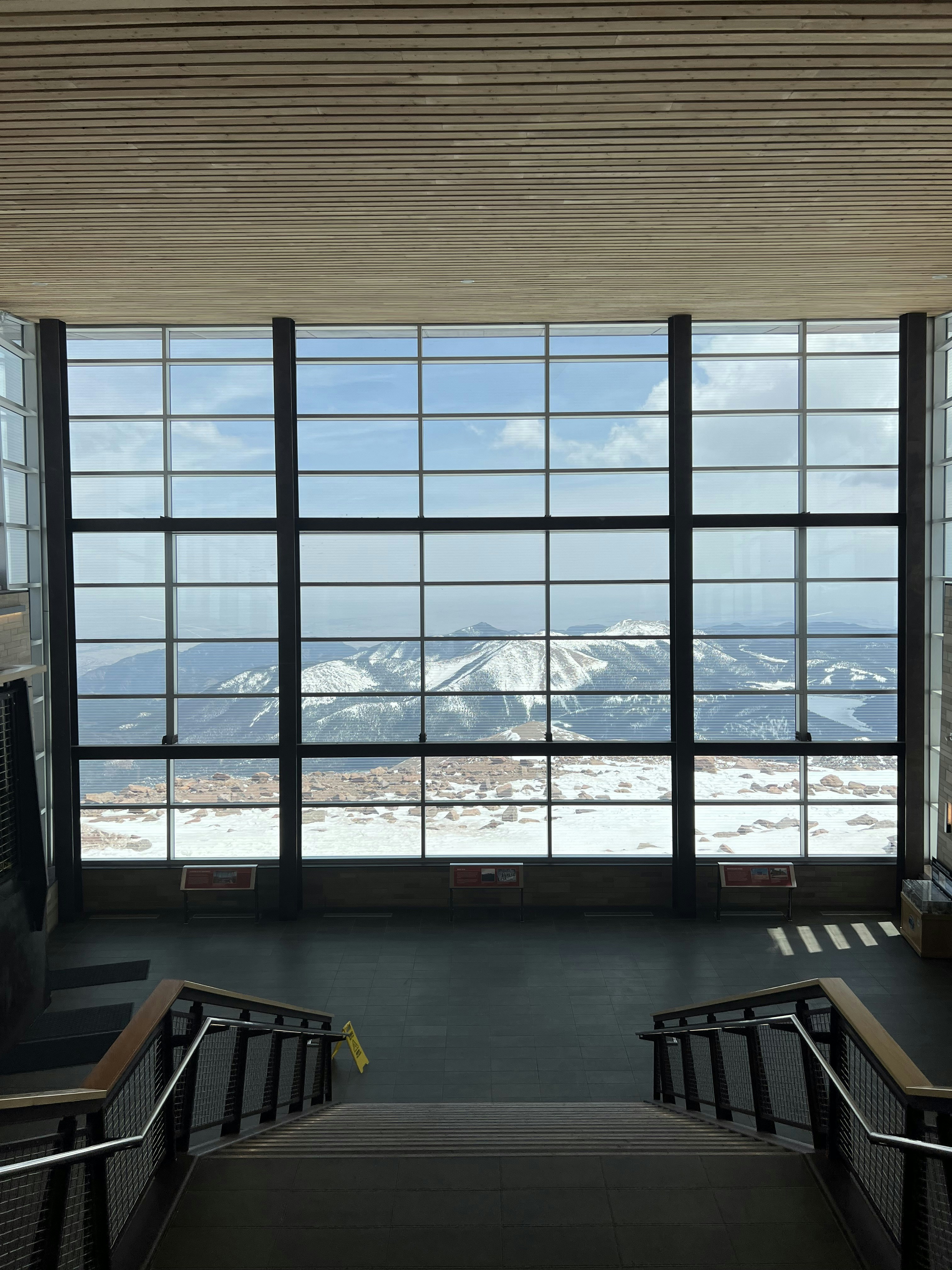 A view of a mountain through a large window photo – Free Image on Unsplash