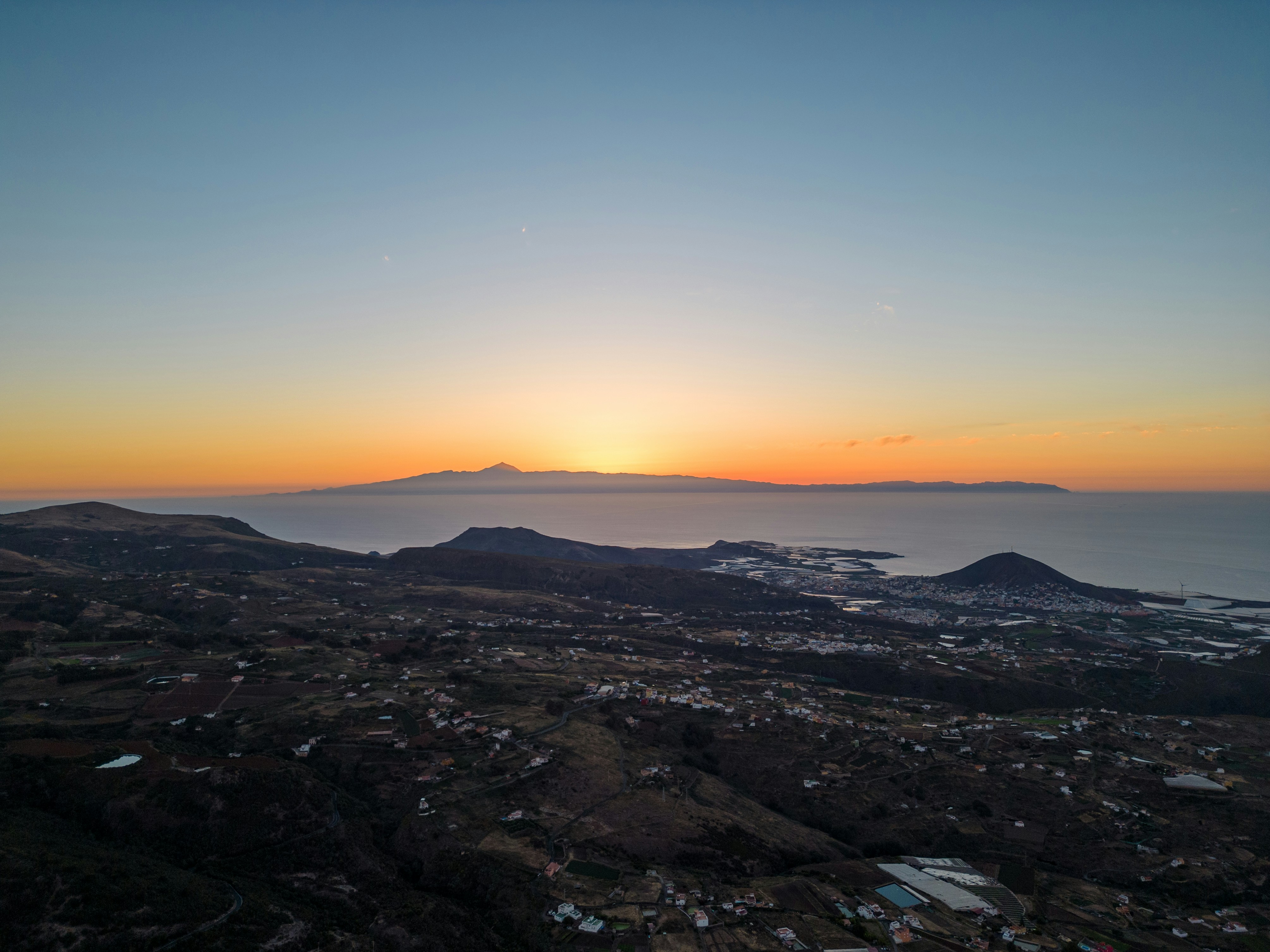 Sunset at the Island Horizon: Coastal Ridge and Distant Isles