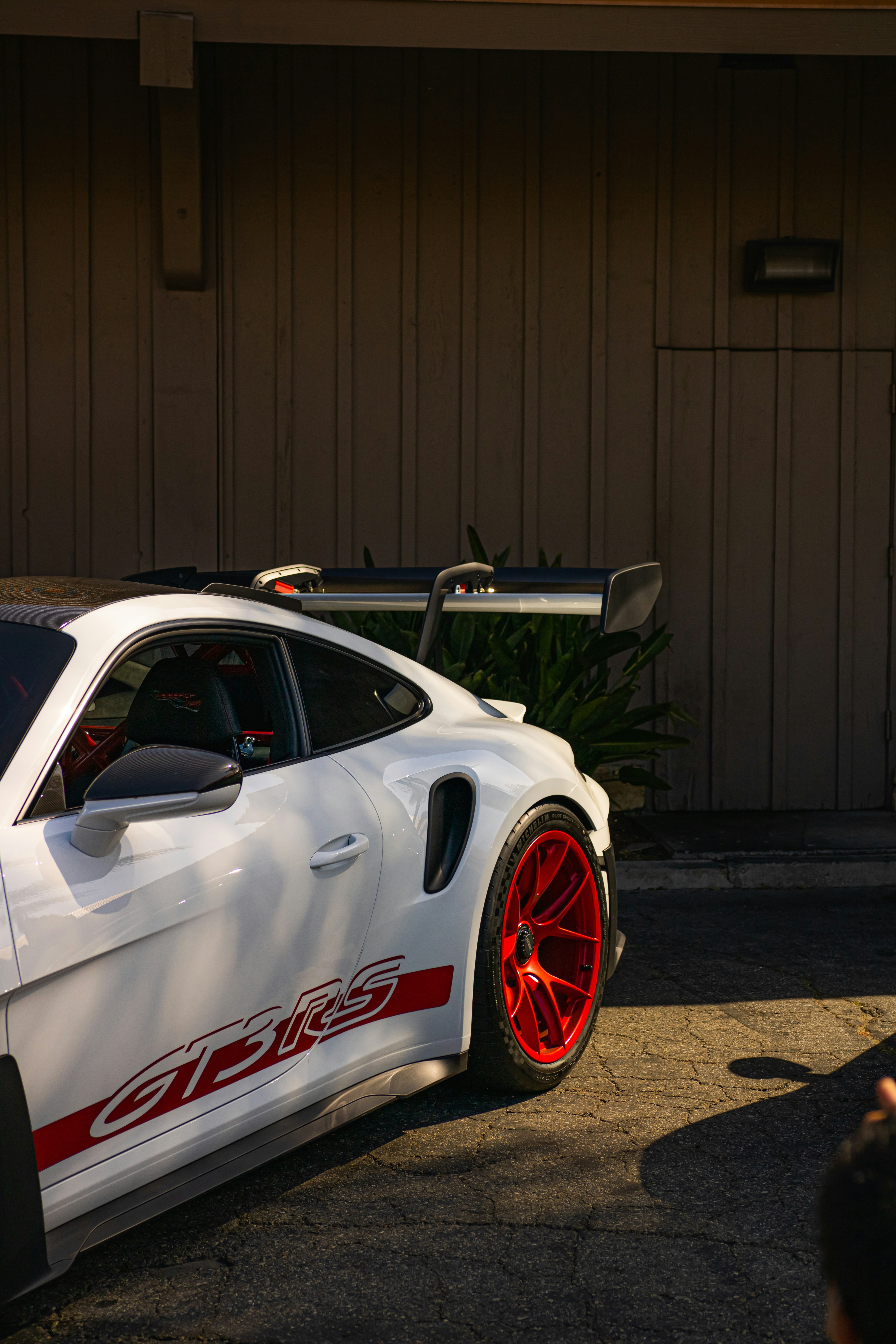 A white sports car parked in front of a building photo – Free Street ...