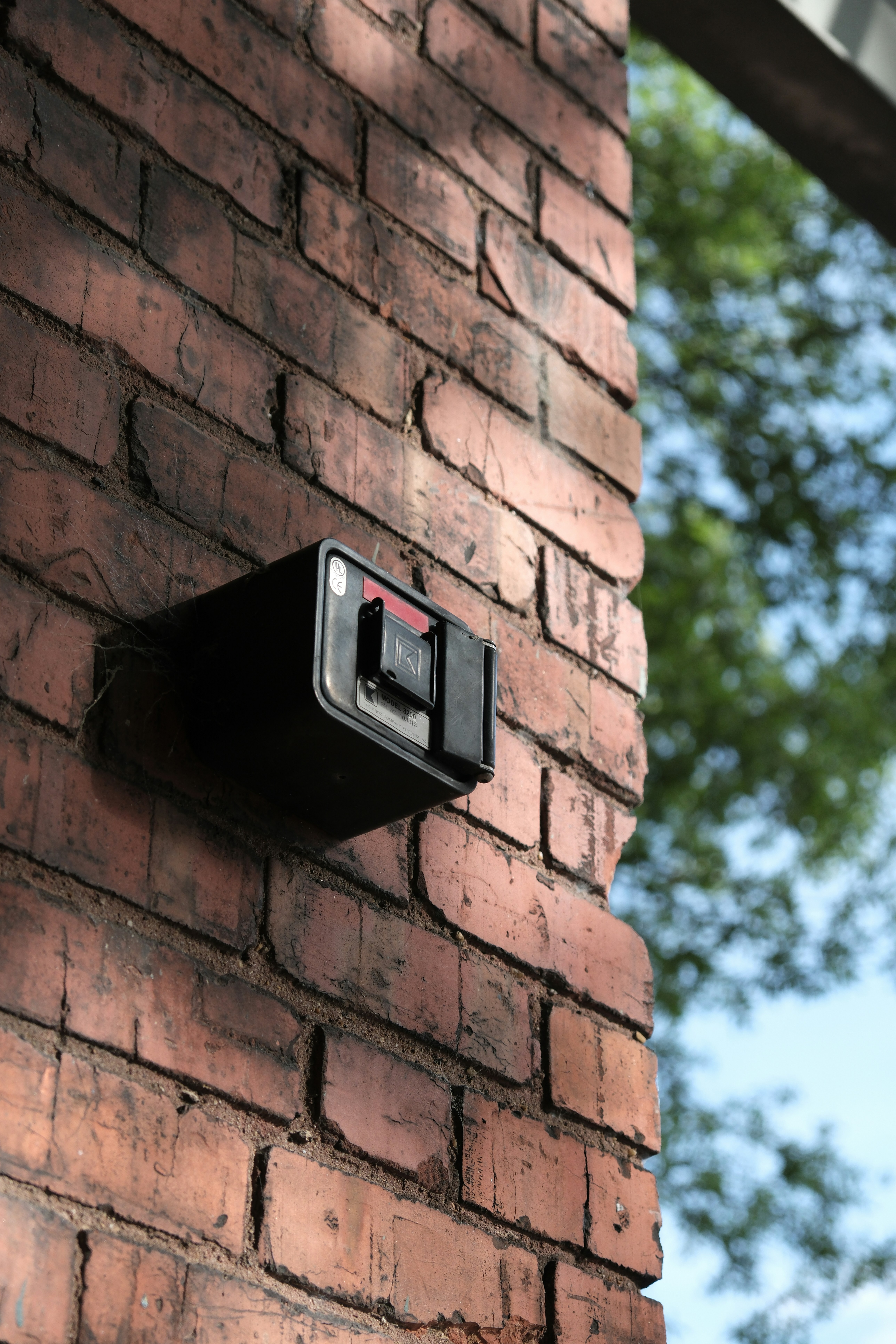 A black electrical outlet on a brick wall photo – Free Security Image ...