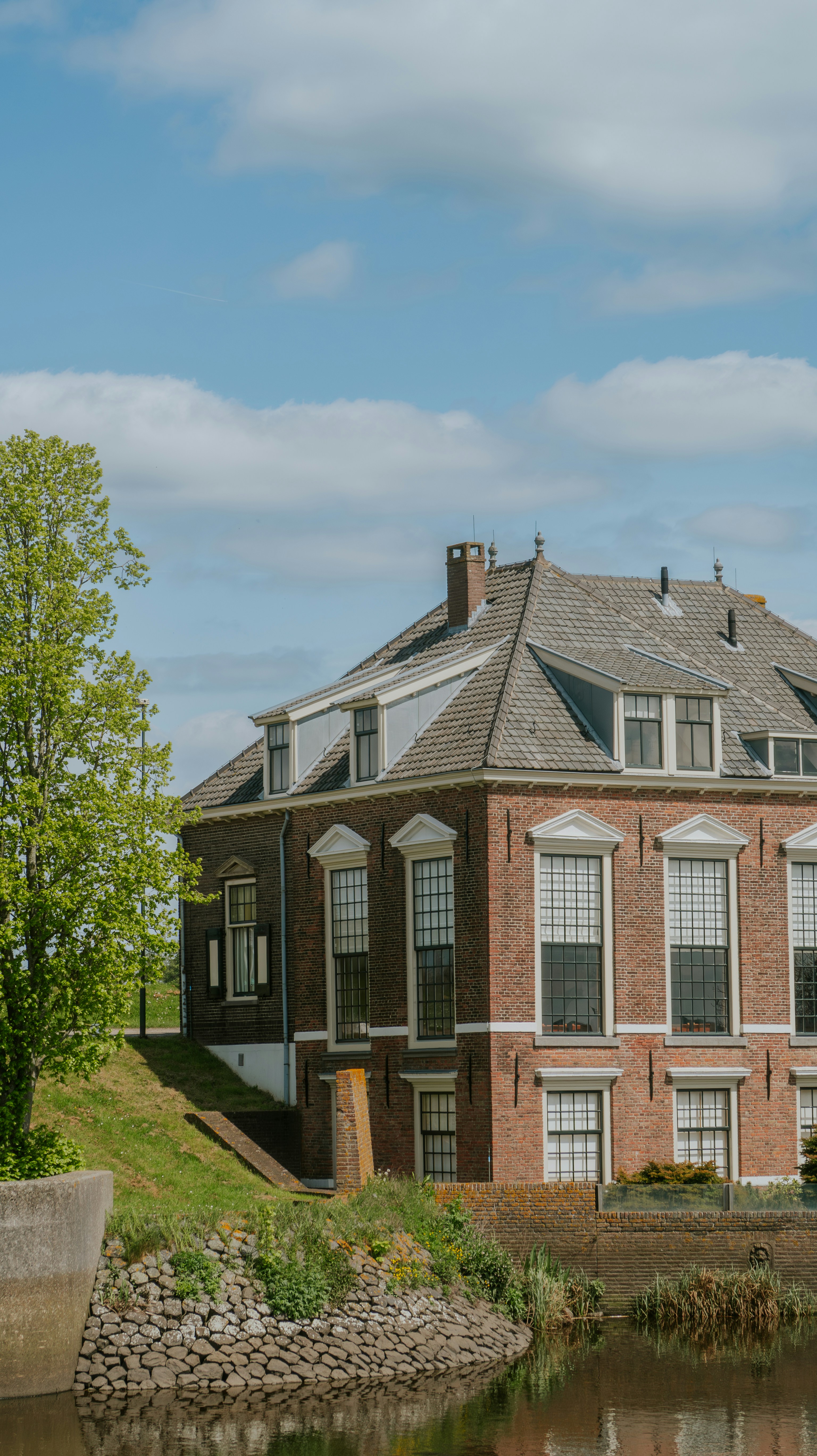 Canalfront Brick Manor Framed by Willow and Water