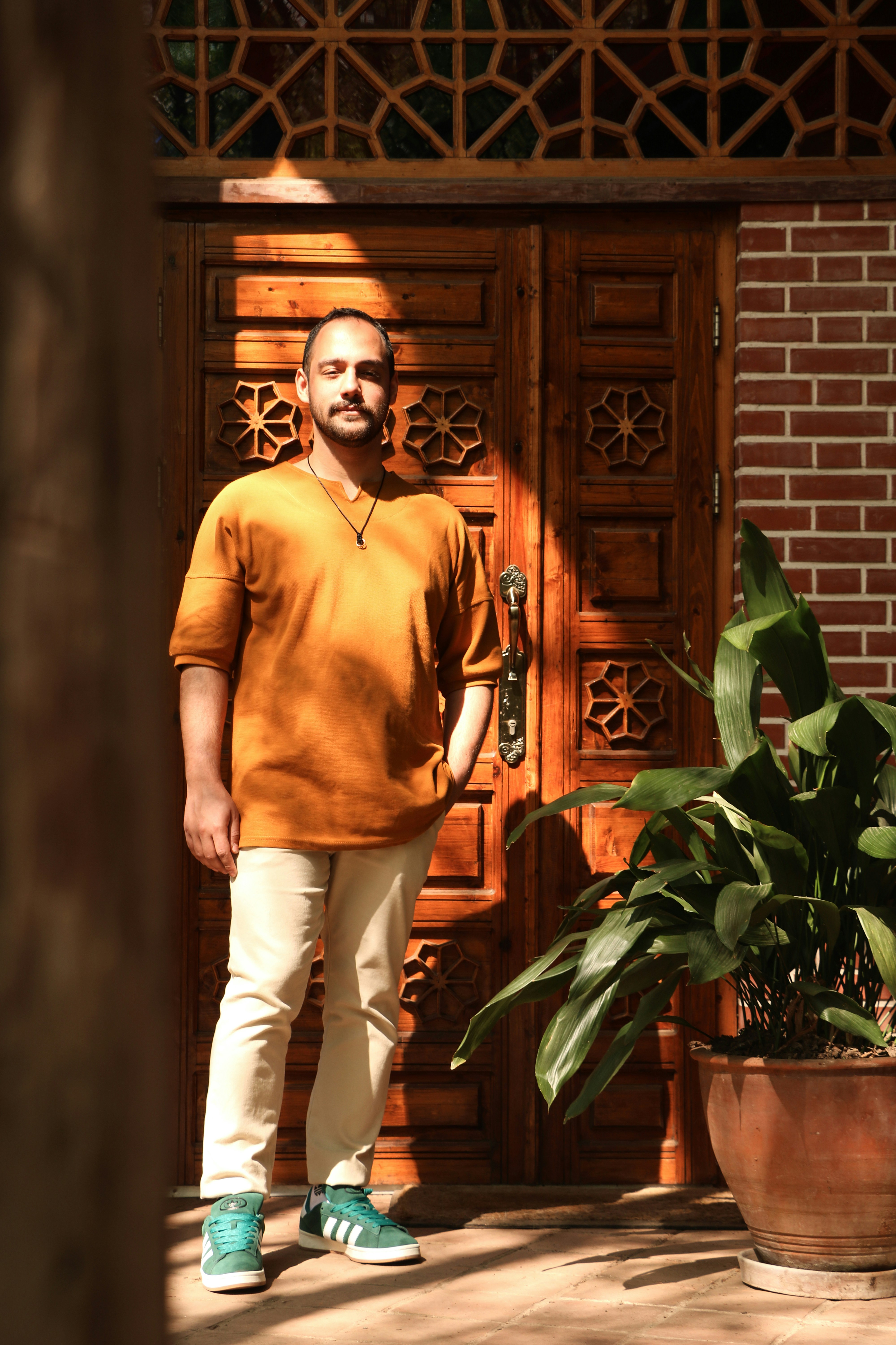 Threshold Light: Portrait Beneath a Carved Wooden Doorway