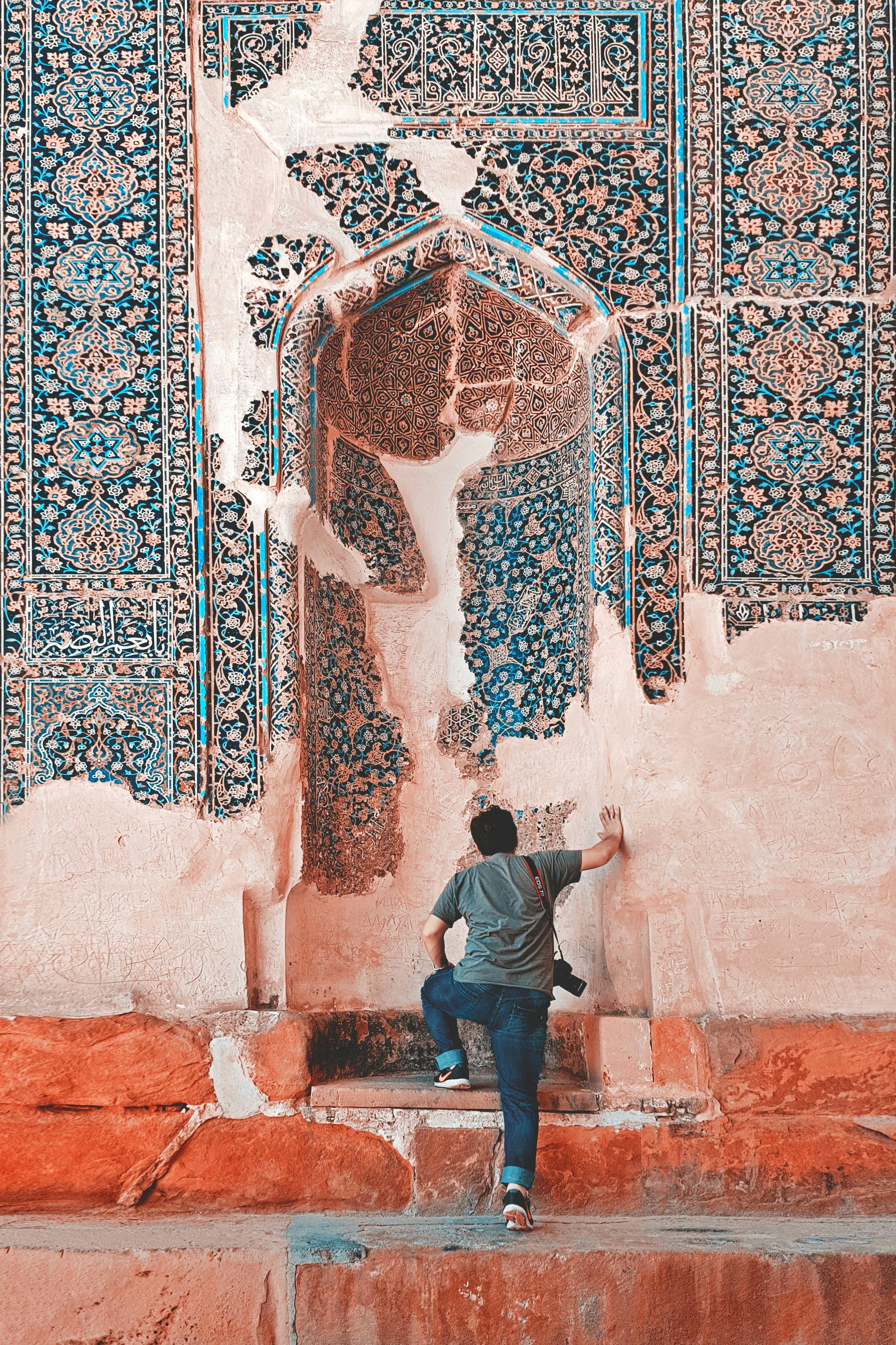 Climber Beneath a Turquoise Mosaic Arch