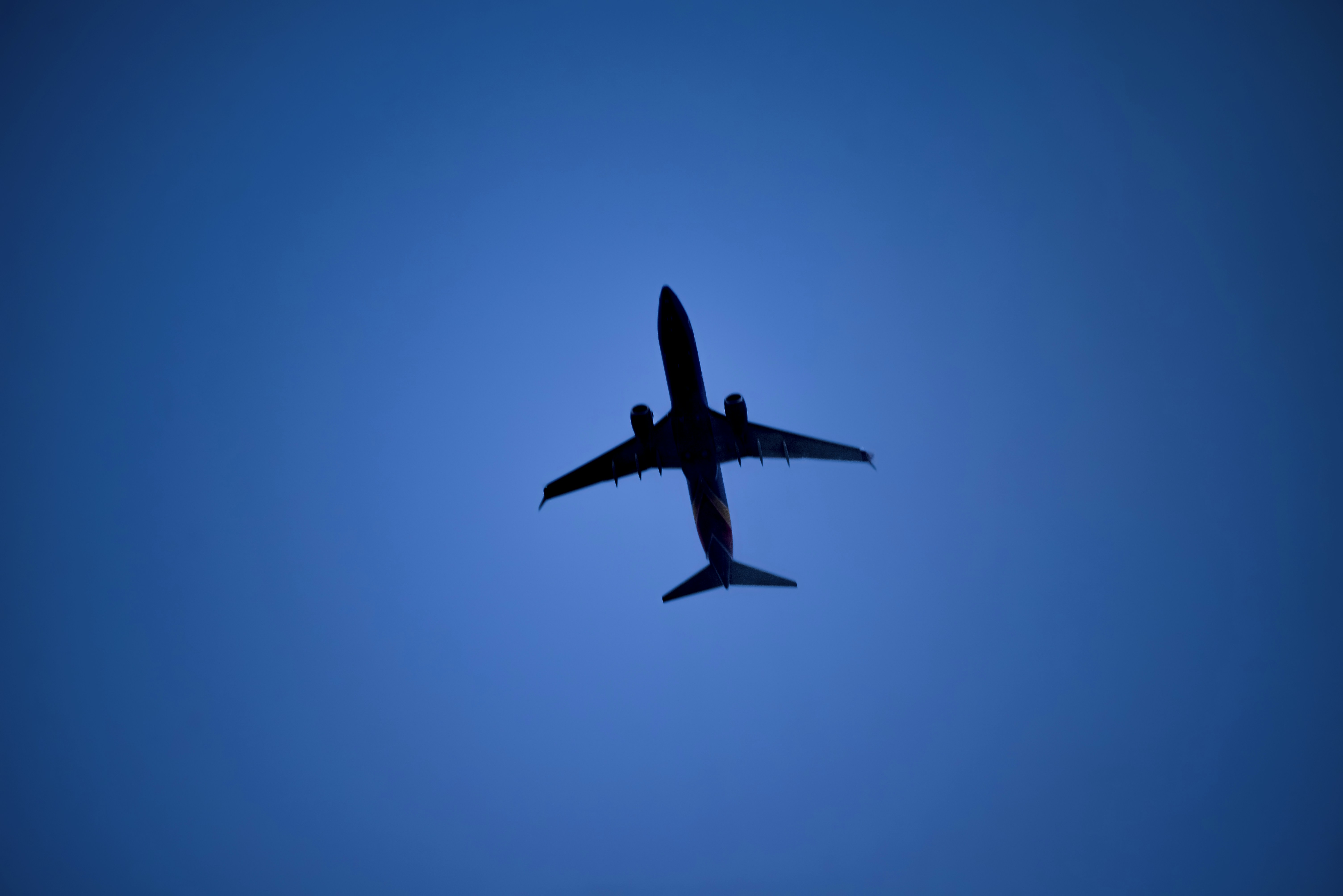 Lone Jet in a Cobalt Canopy: Aerial Silhouette