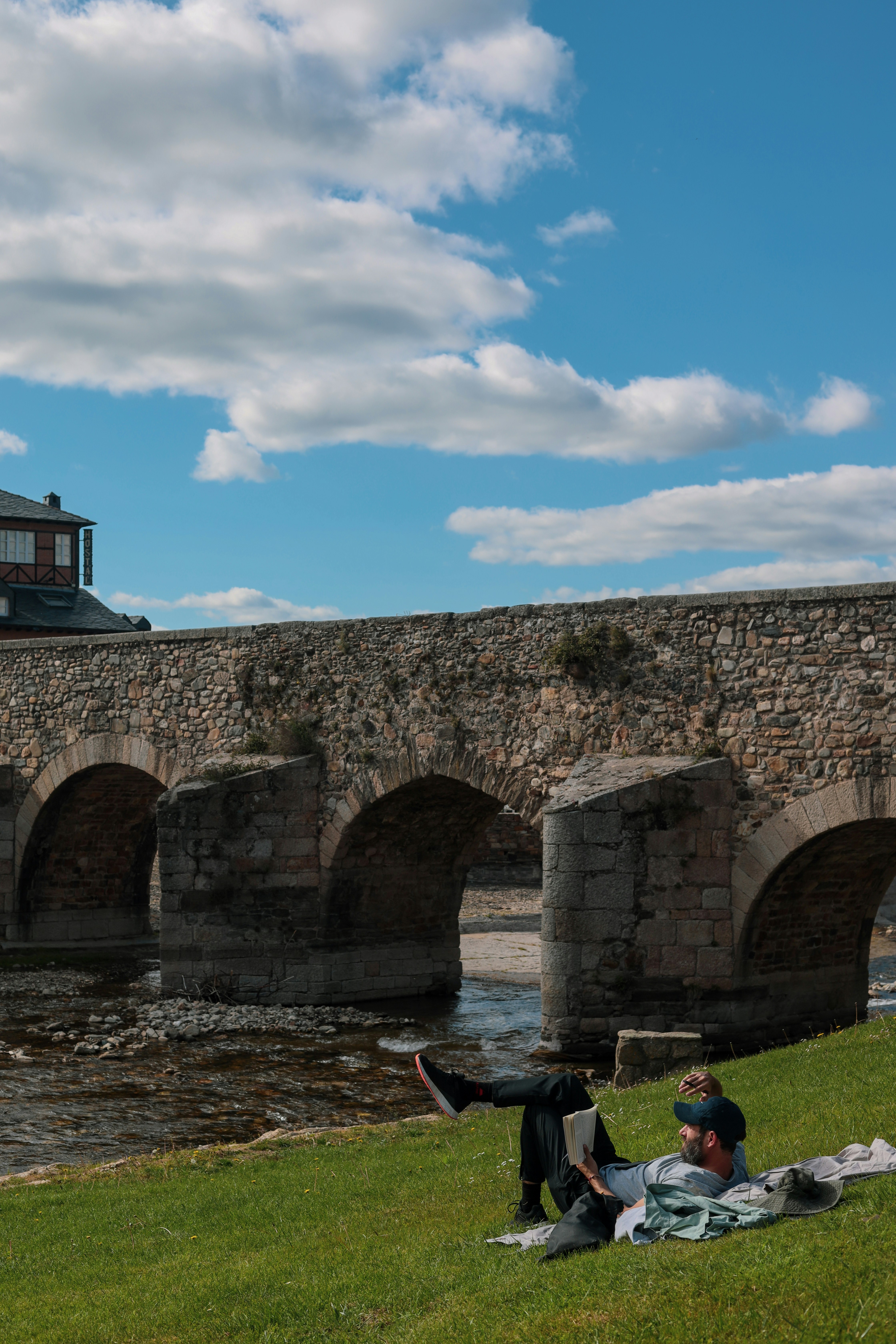 Quiet Riverside Pause Beneath the Stone Arches