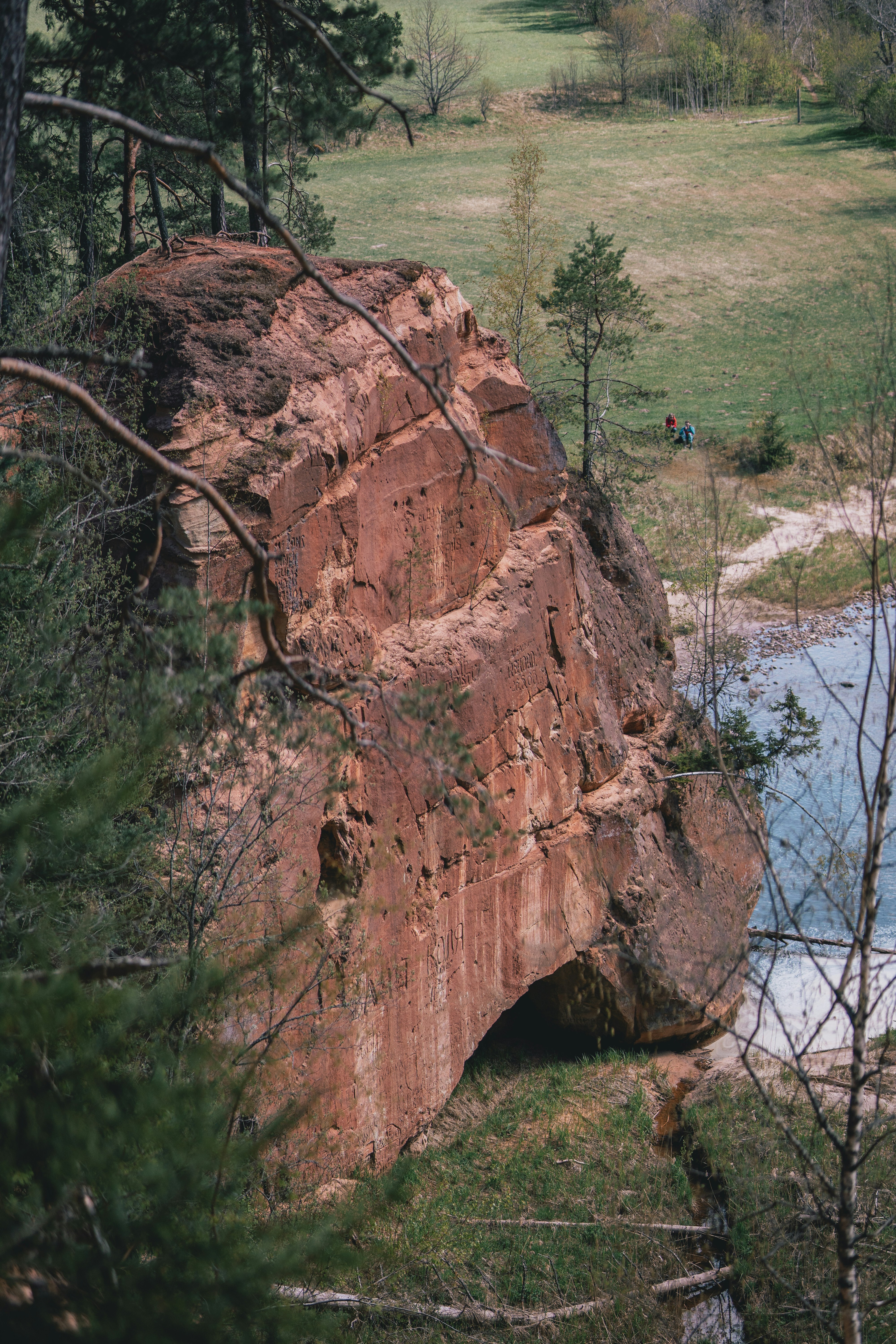 Red Outcrop Overlooking a Quiet Riverside Clearing