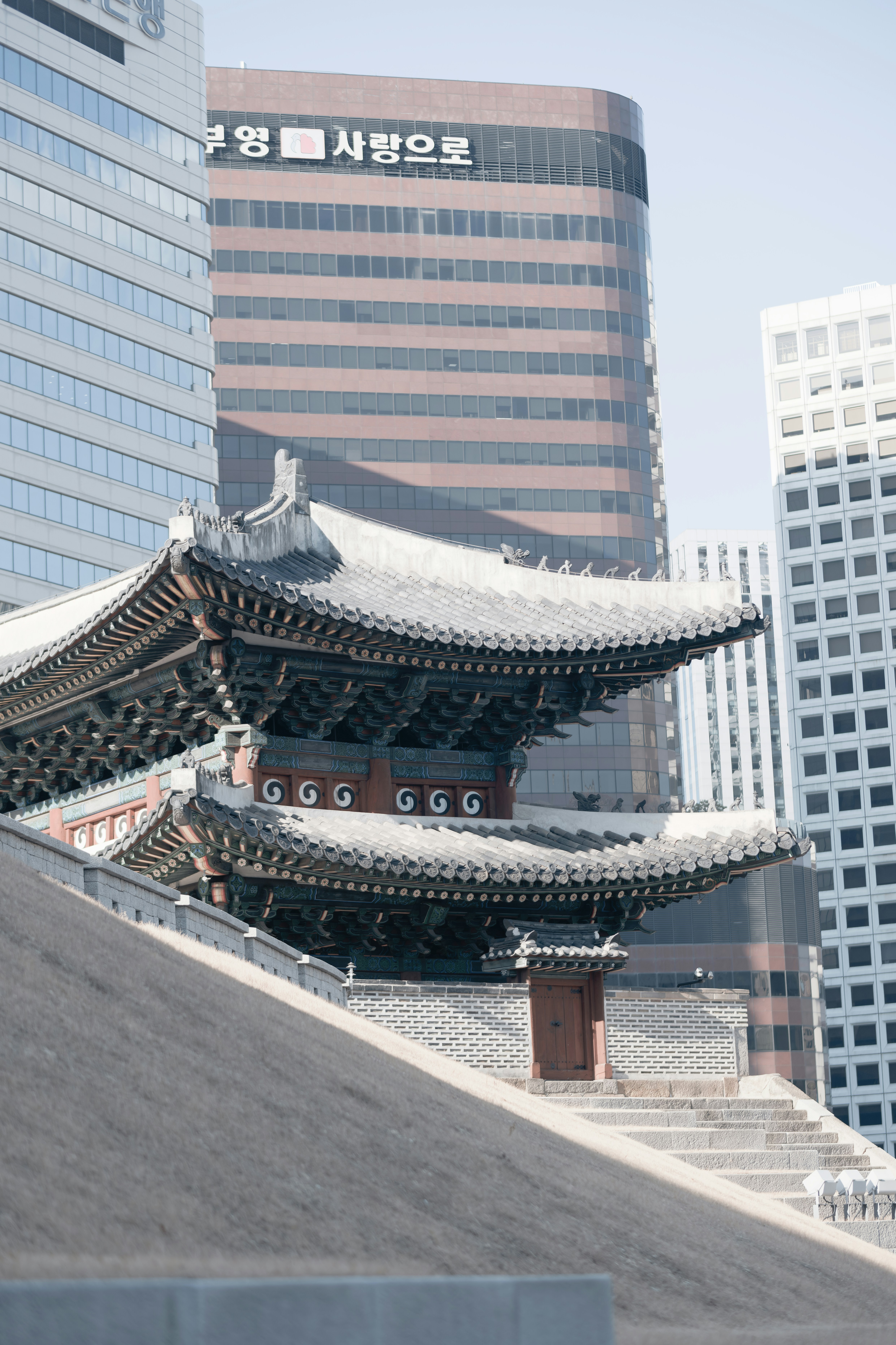 A tall building sitting next to a tall building photo – Free Namdaemun ...