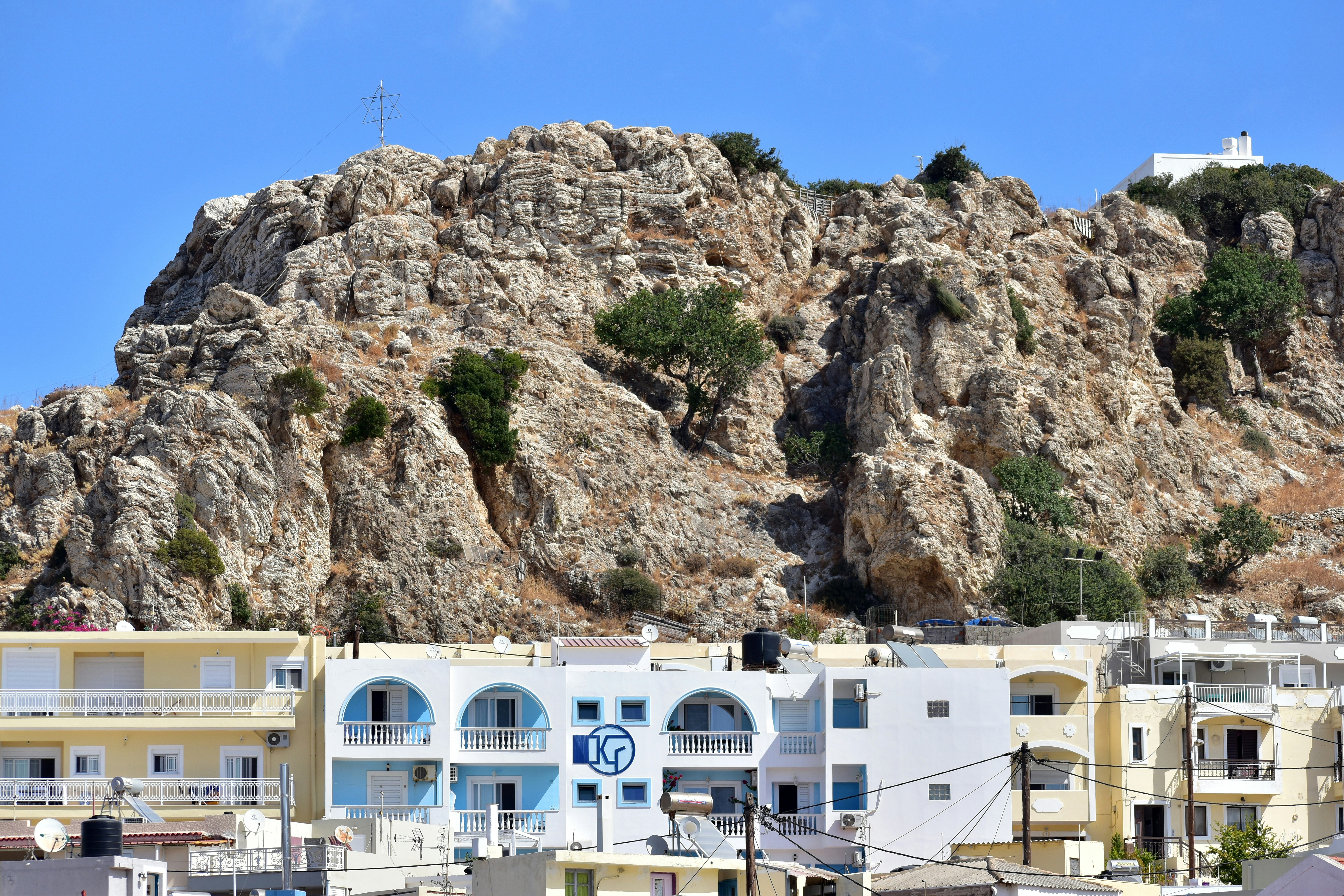 Cliffside Village Beneath Sunlit Granite Ridges