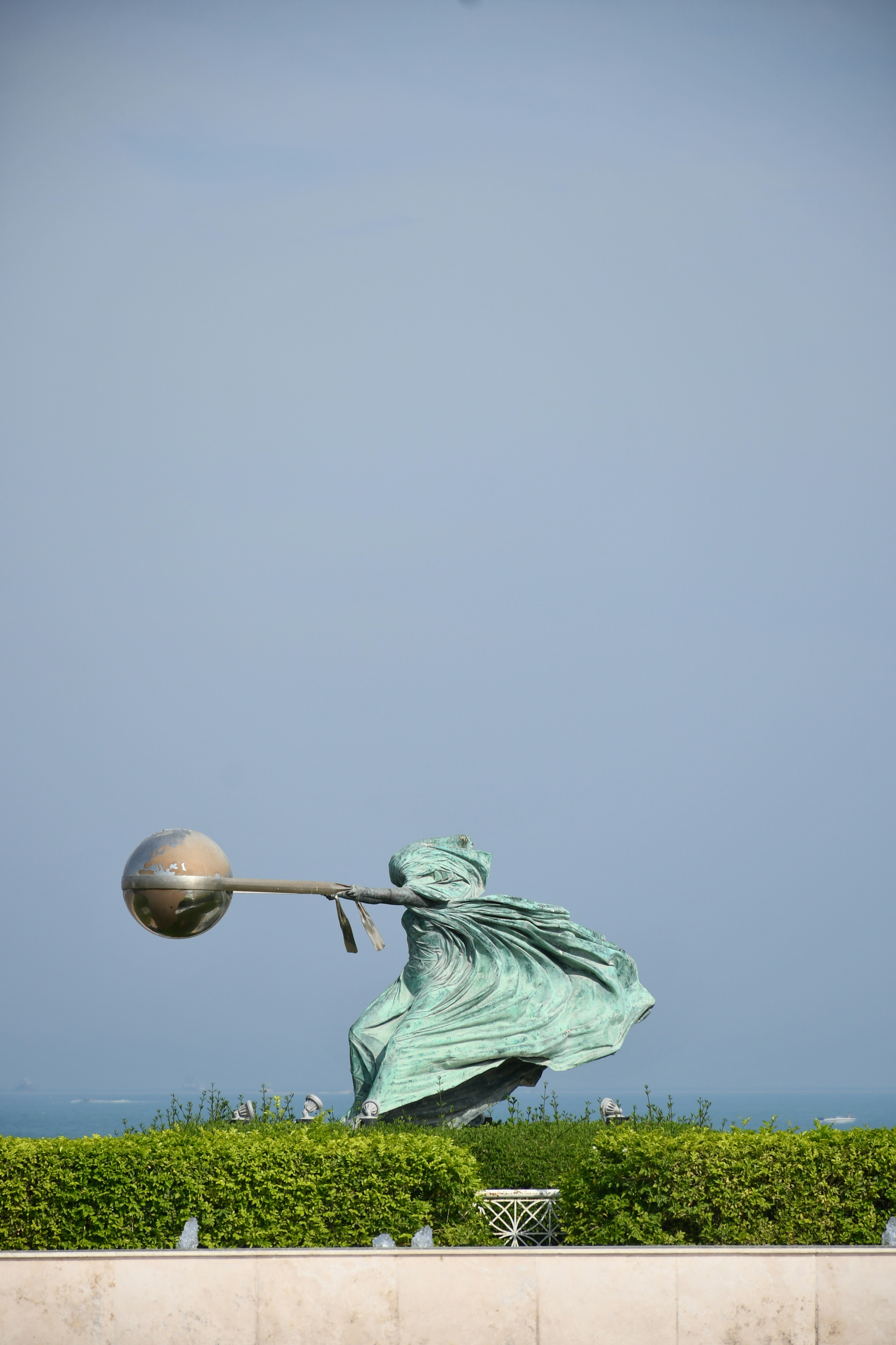 Windward Cloak: Bronze Figure Above the Sea-Edge Garden