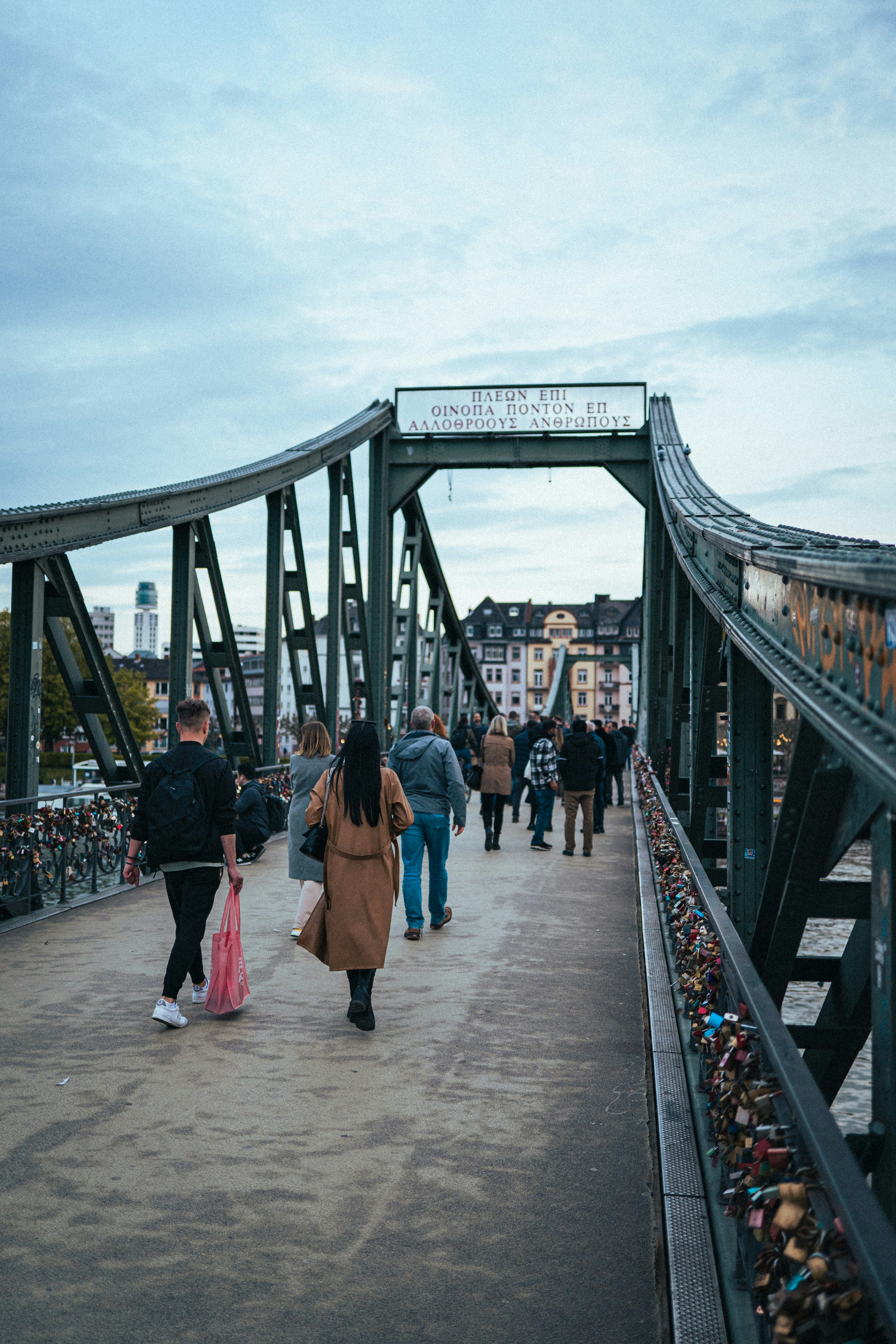 A group of people walking across a bridge photo – Free Deutschland ...