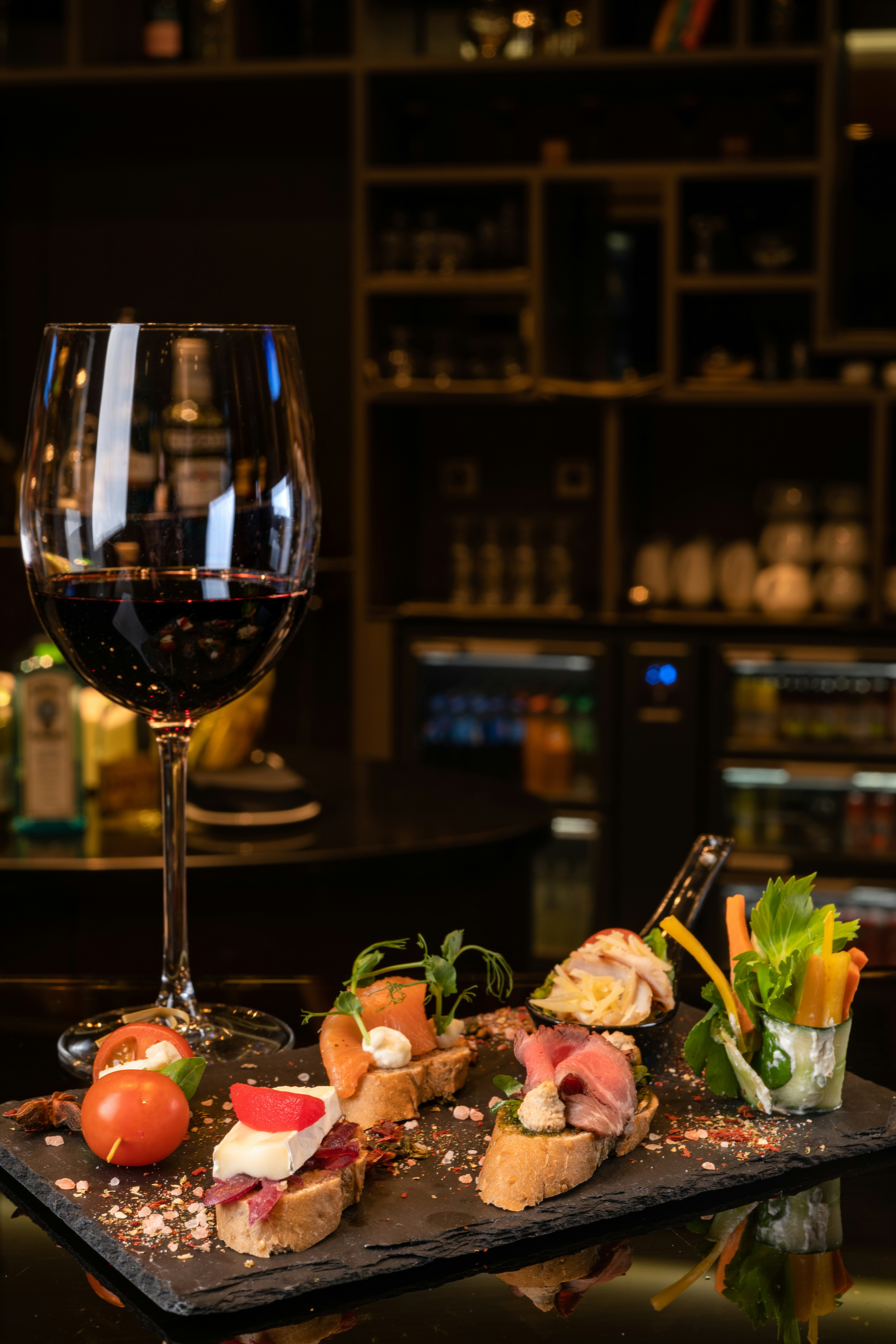 Crimson Glass and Slate Bites: A Bar-Top Still Life
