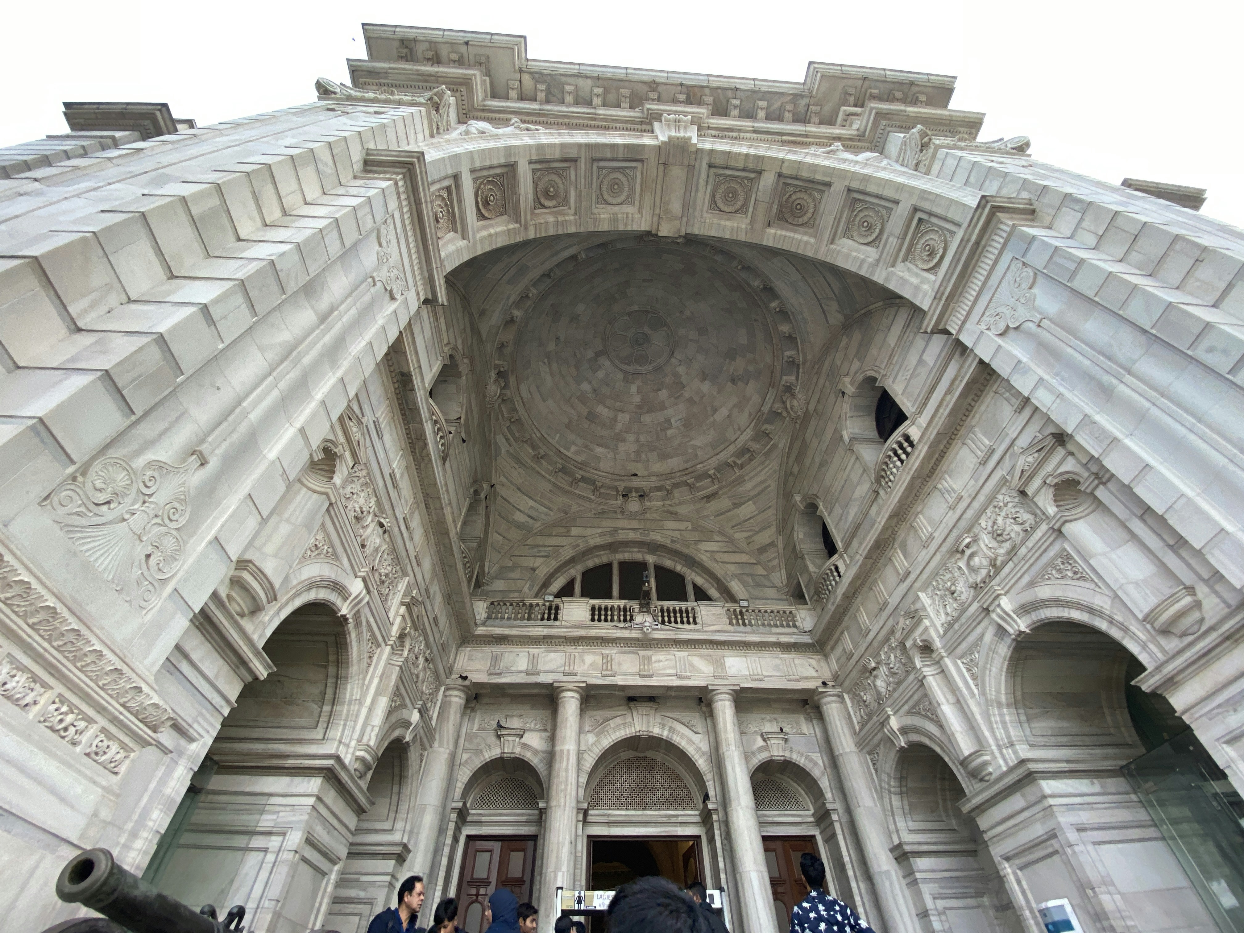 Under the Grand Arch: A Low-Angle Portrait of Marble Facade