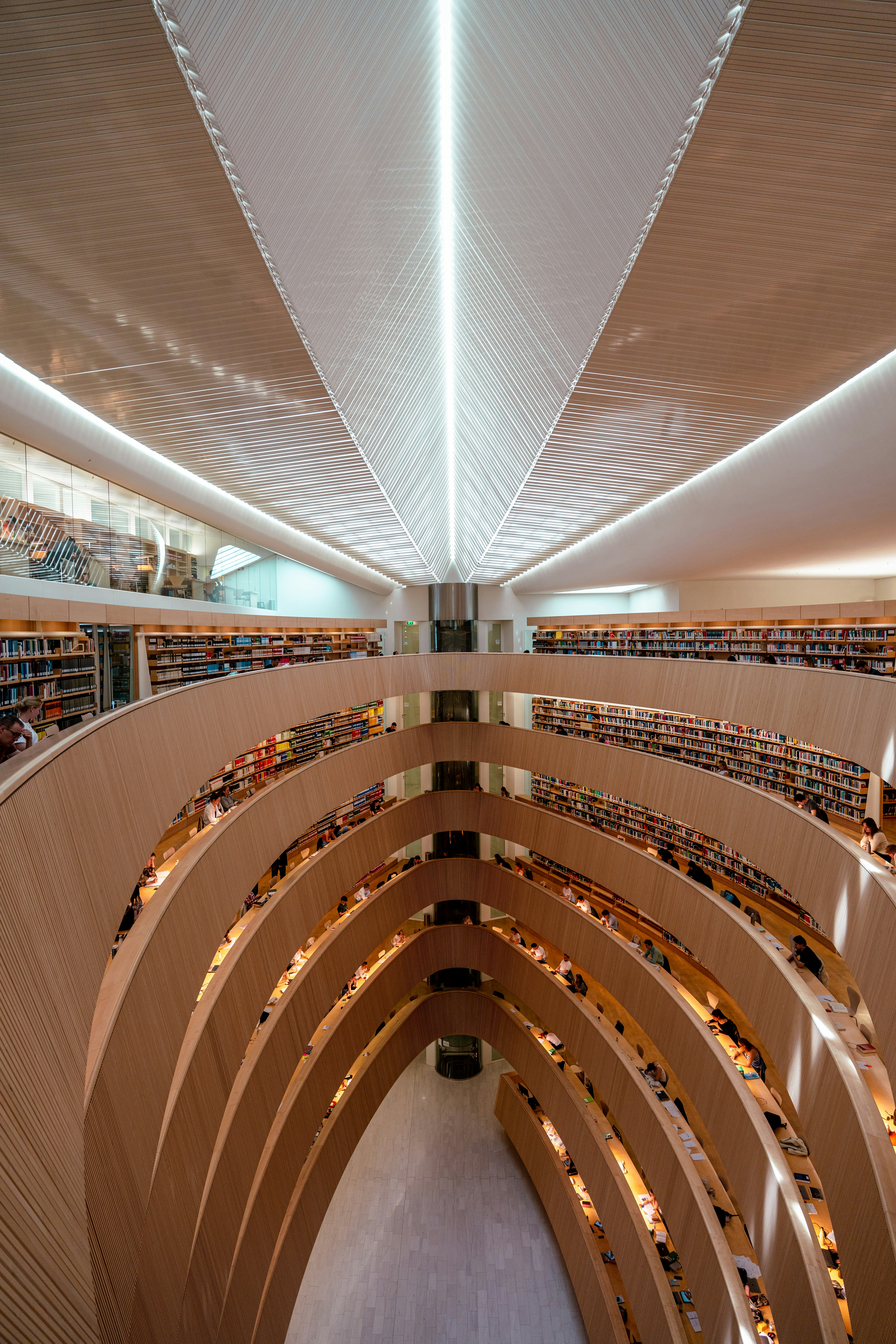 The interior of a large library filled with lots of books photo – Free ...