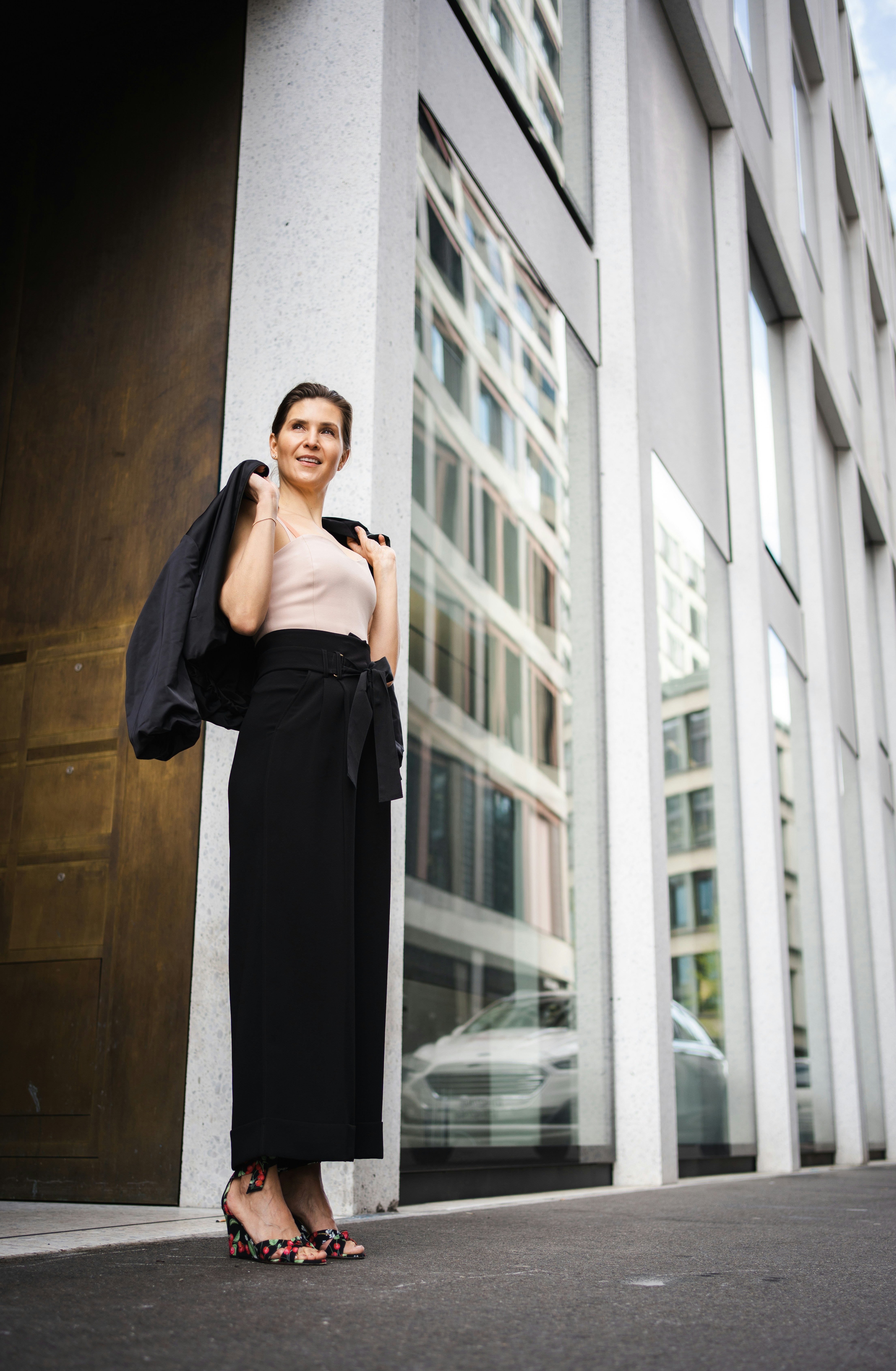 Urban Poise by the Glass Facade: A Portrait in Concrete Light
