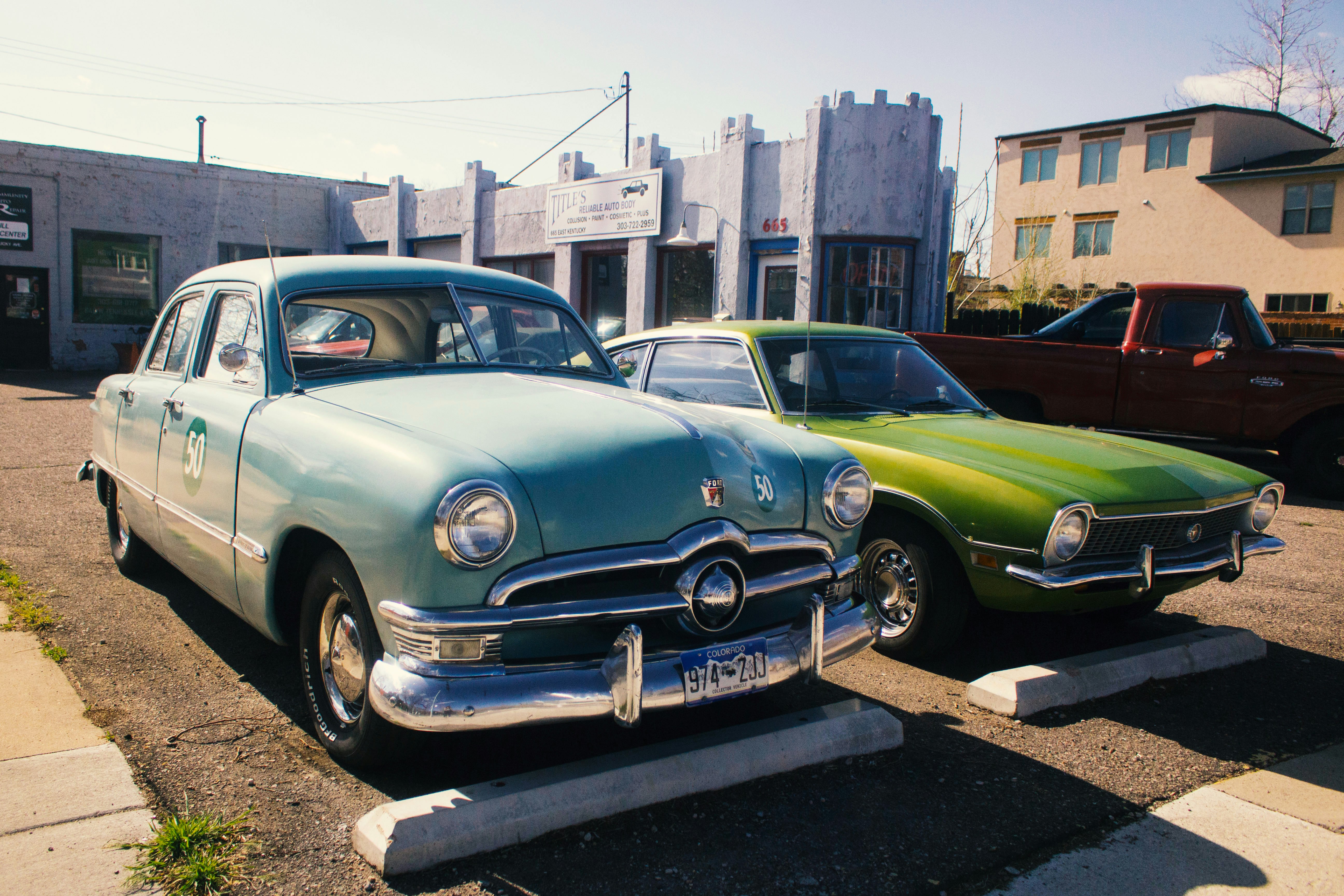 Pastel Cruisers: A Sunlit Standoff of Vintage Cars