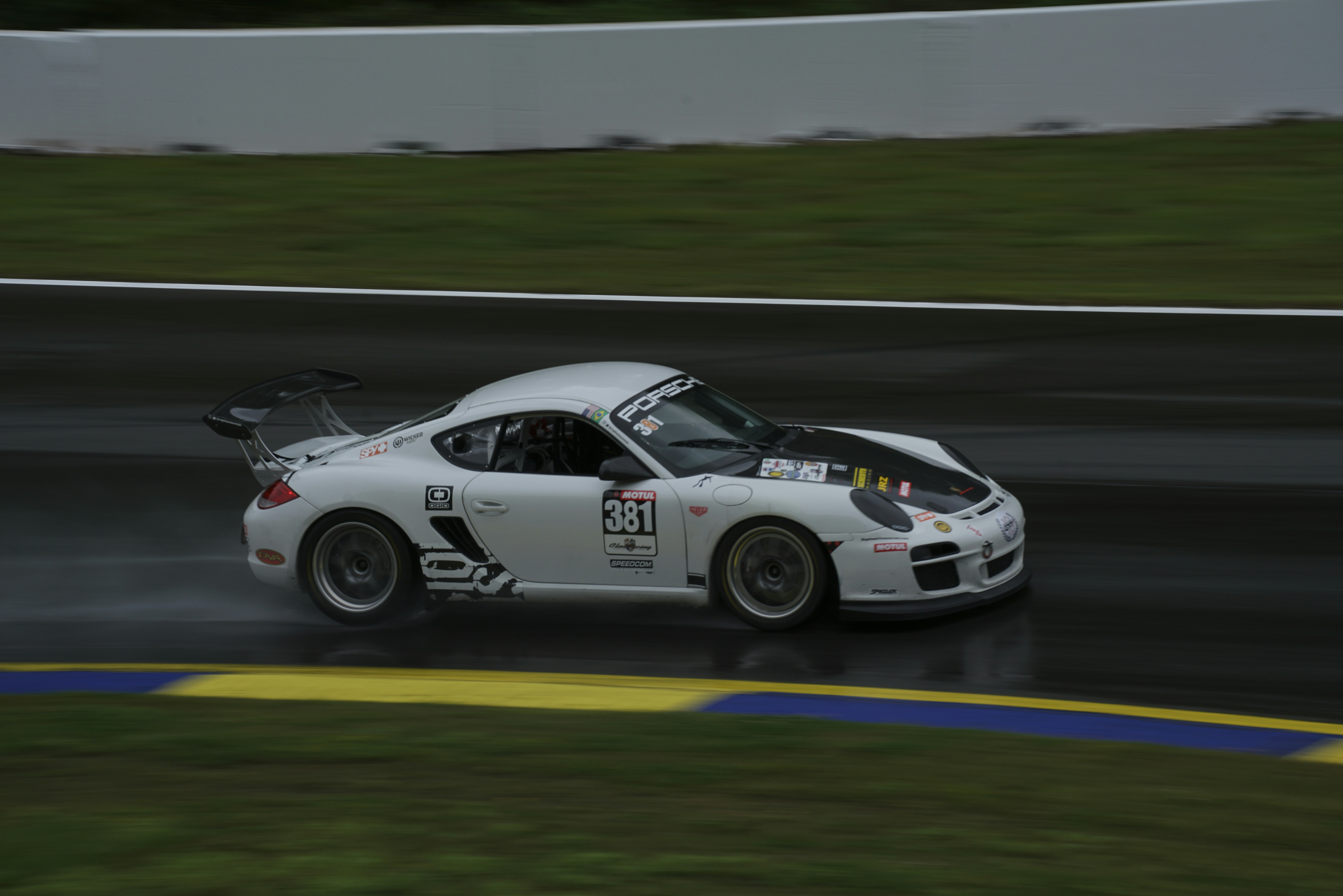 A white sports car driving on a wet track photo – Free Porshce Image on ...