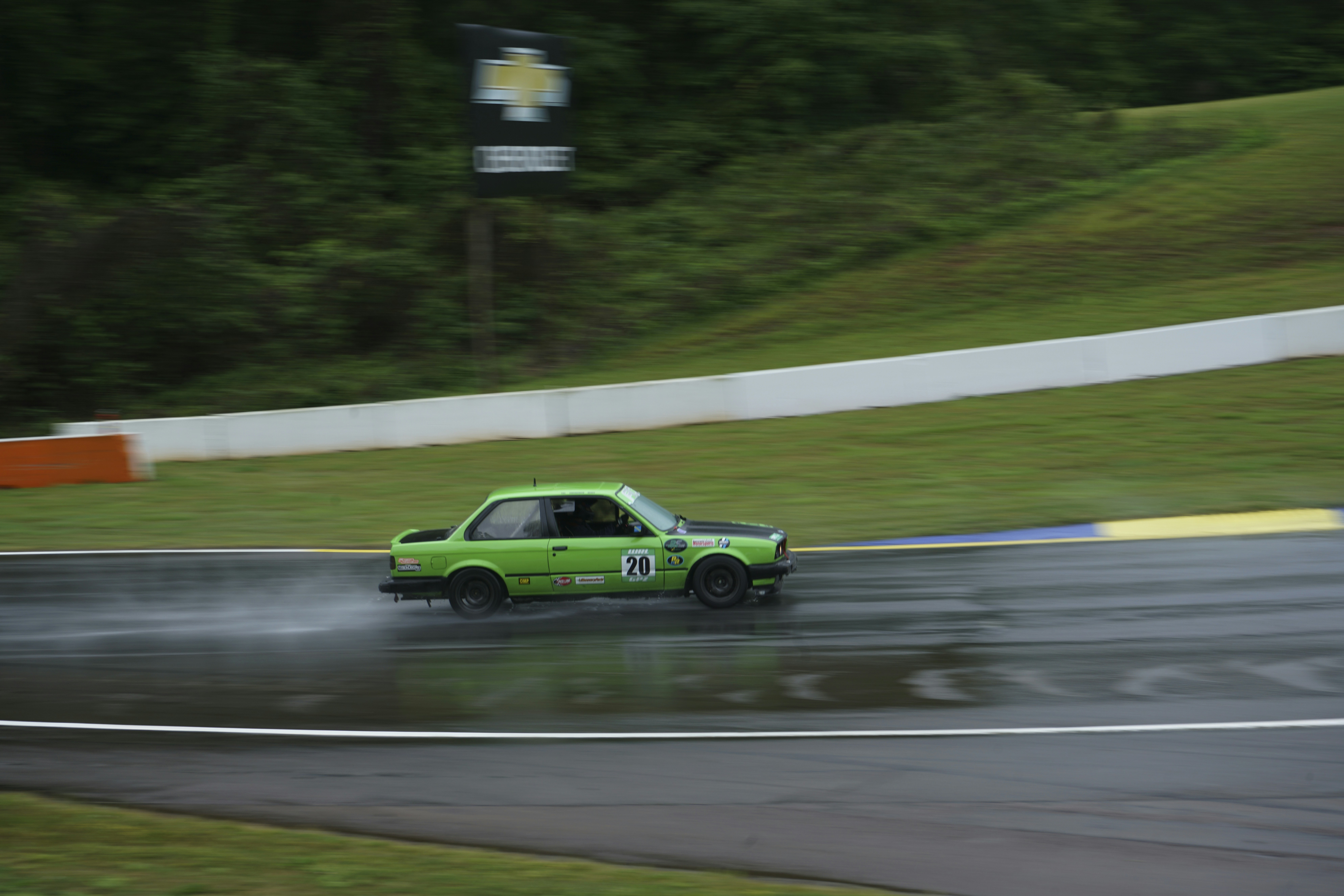 Lime Lightning on Wet Asphalt: #20 Skims the Curve