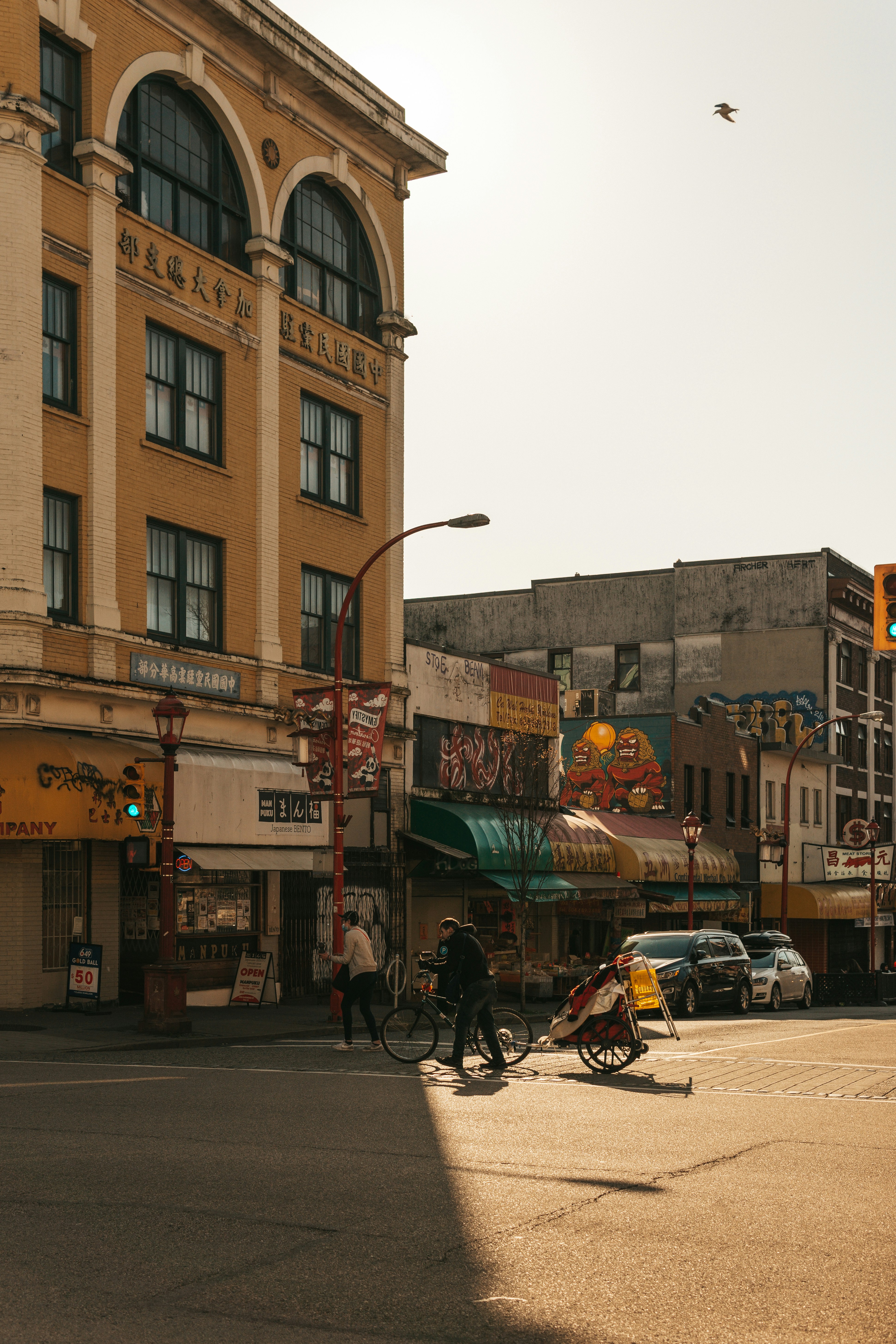 Person crossing while pulling a bike.