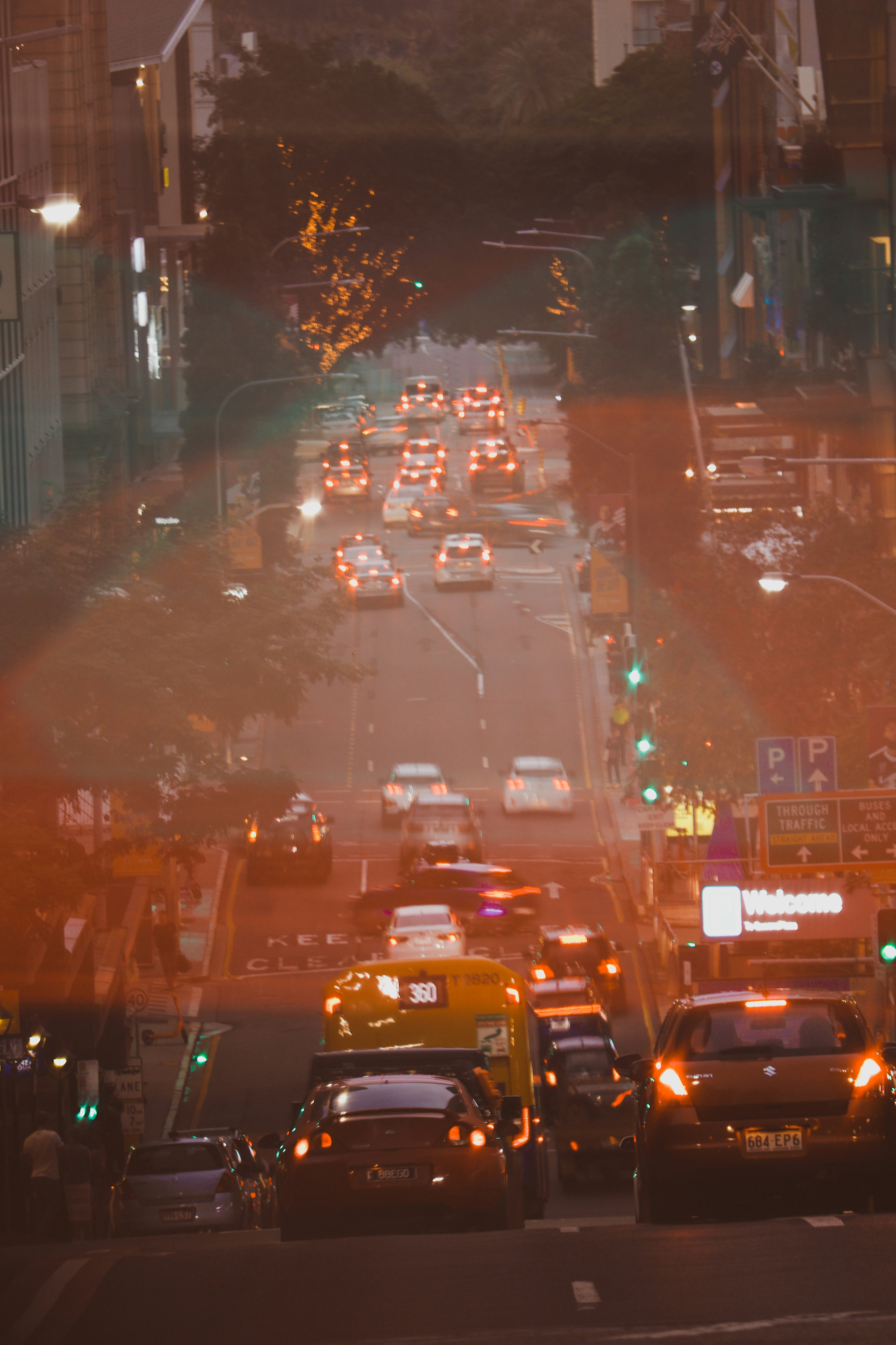 Amber Veil on an Urban Avenue: Night Traffic Through a Glassy Glow