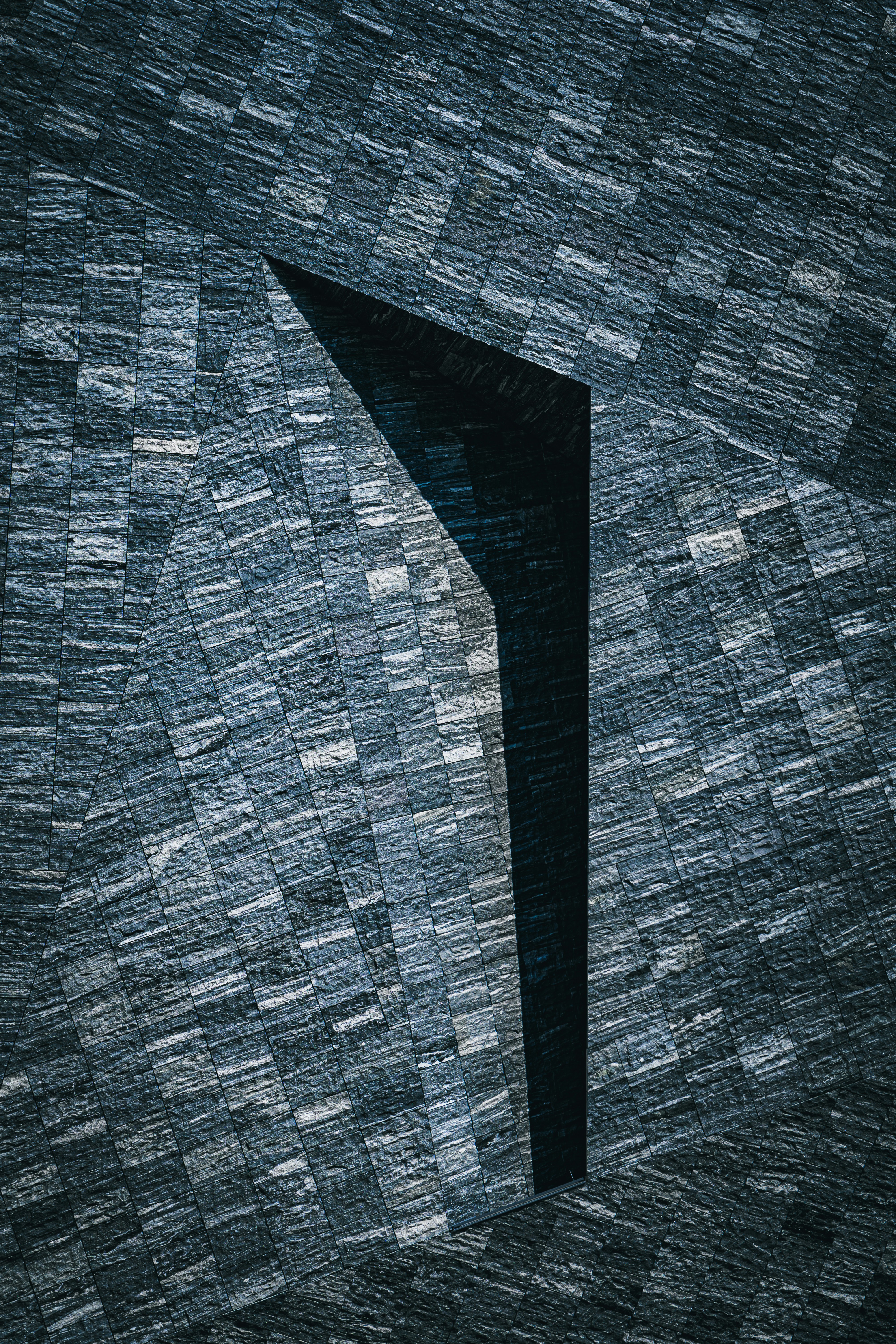 Threshold in Stone: A Narrow Dark Portal Among Faceted Gray Blocks