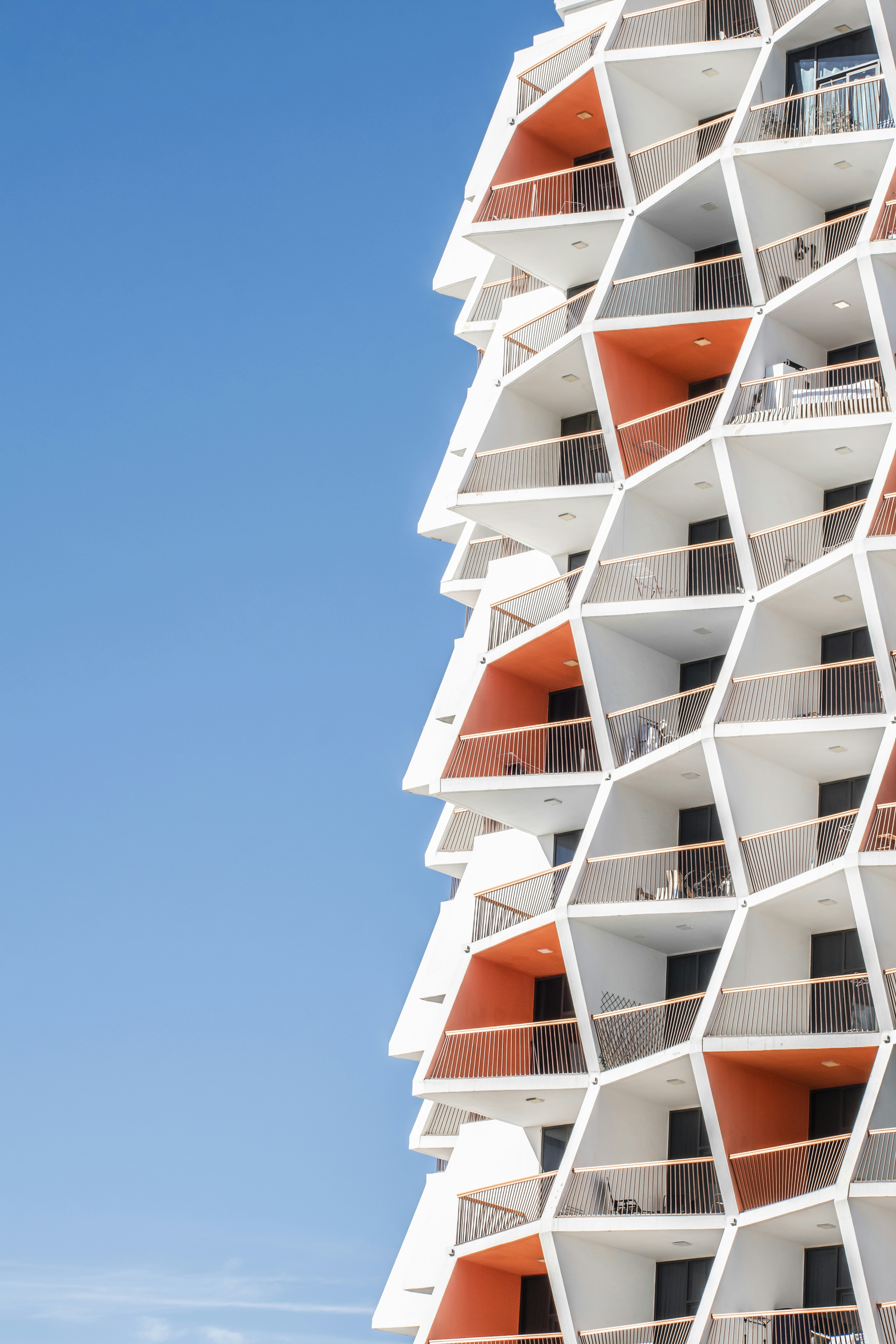 A very tall building with balconies and balconies on the sides photo ...