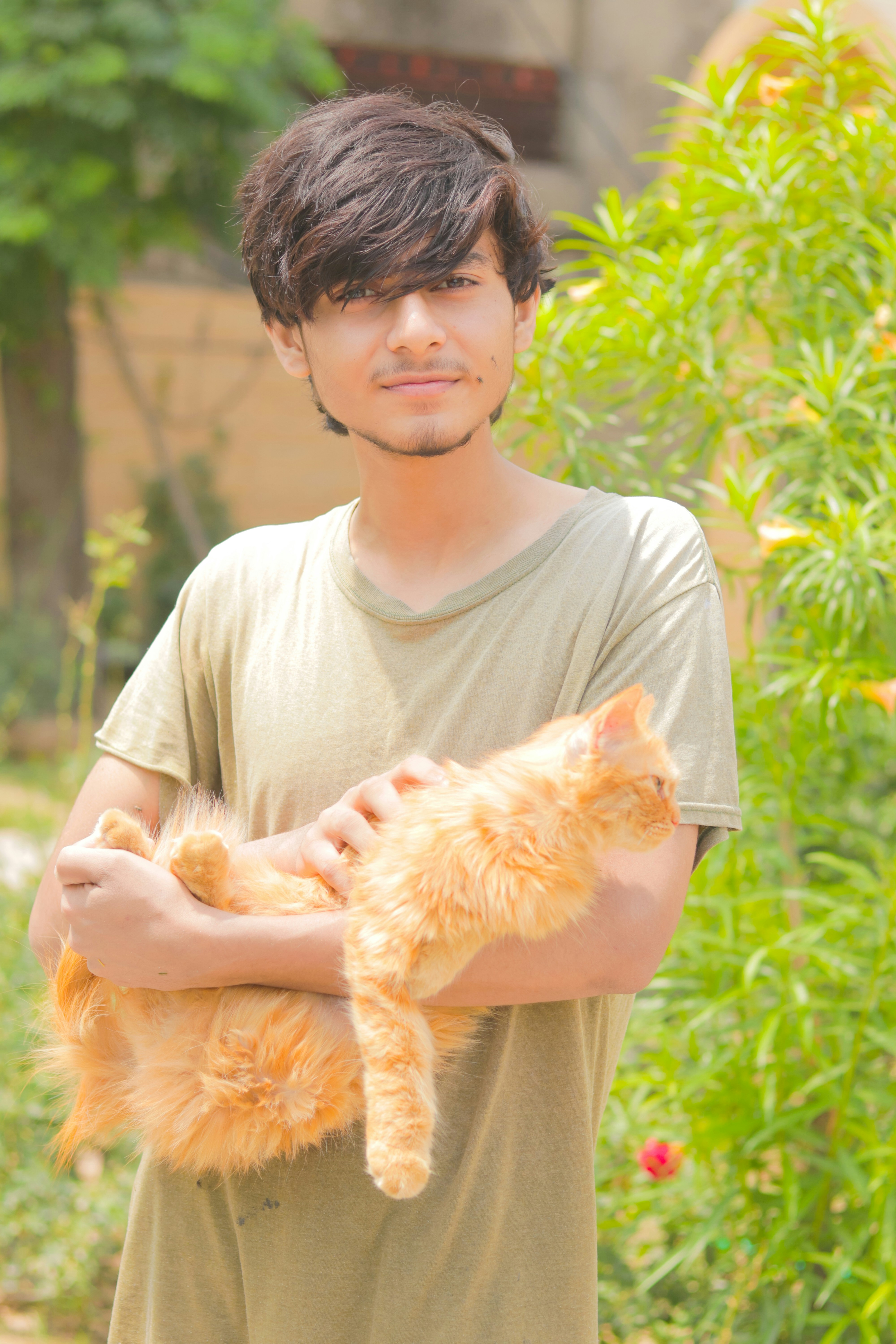 Gentle Portrait: A Youth in a Garden Embracing a Furry Companion