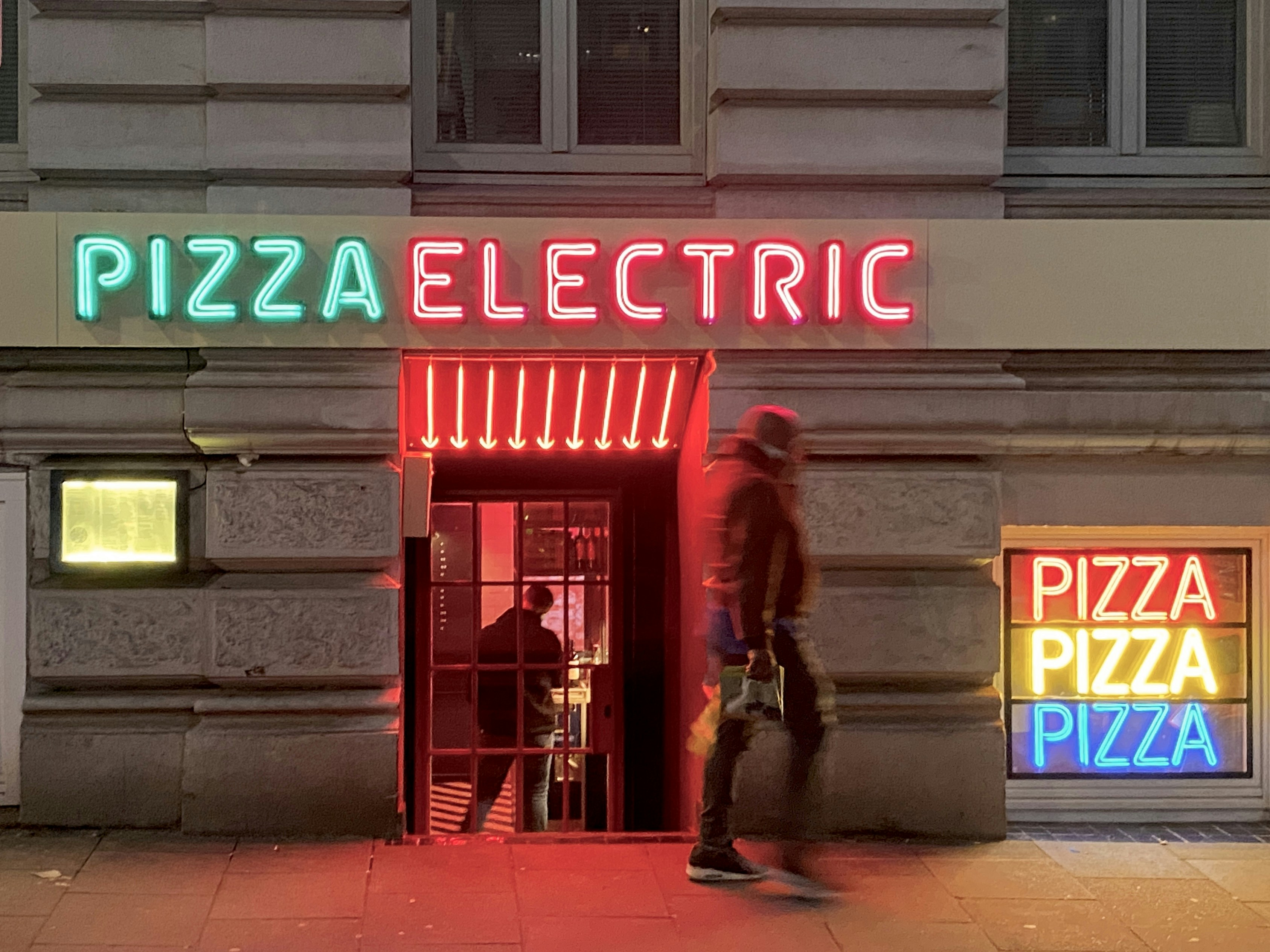 Neon Threshold at Pizza Electric: Red Glow by the Entrance